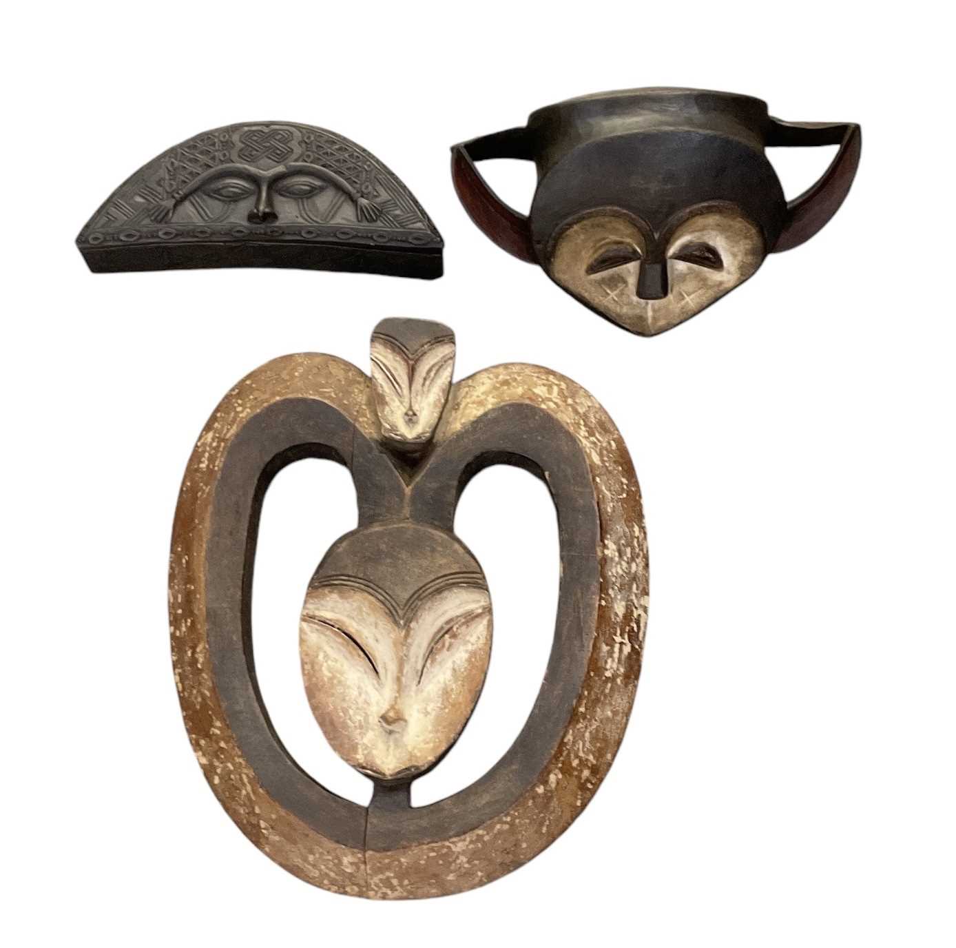 Lot 1047 - Two carved wooden Kwele masks, the larger