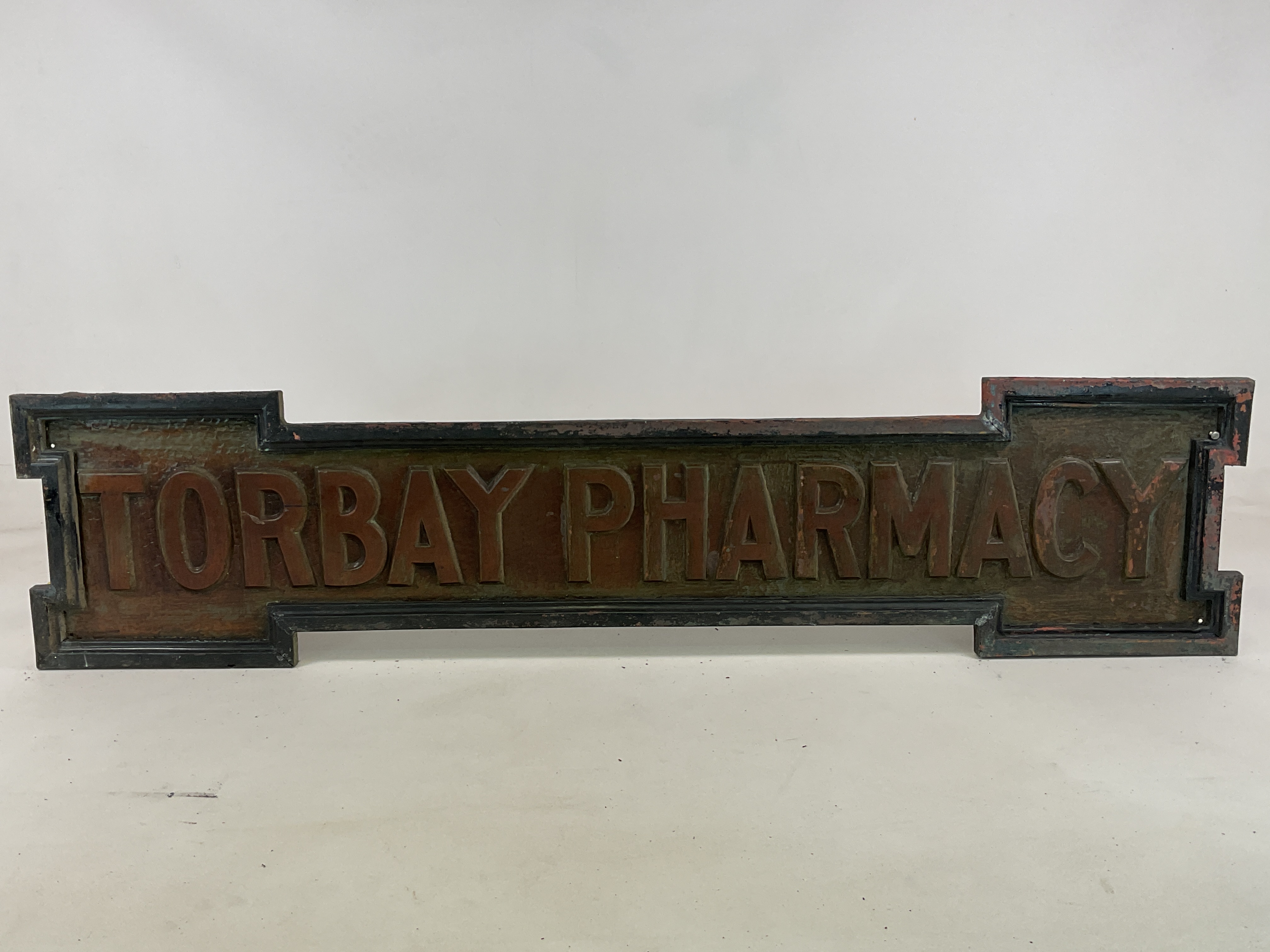 Lot 2 - TORBAY PHARMACY: a hammered copper shop front