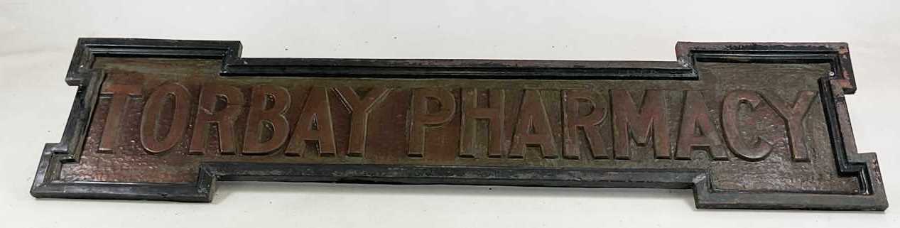 Lot 2 - TORBAY PHARMACY: a hammered copper shop front