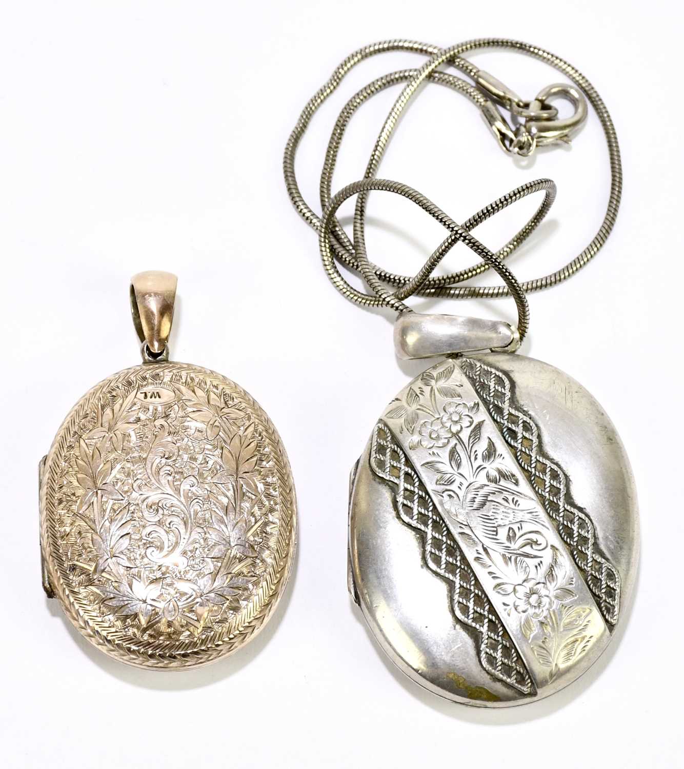 Lot 1404 - An oval silver locket on chain, and a