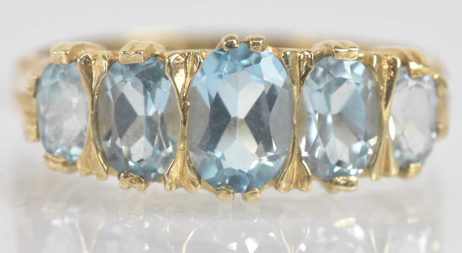 Lot 1321 - A 9ct yellow gold five stone graduated blue