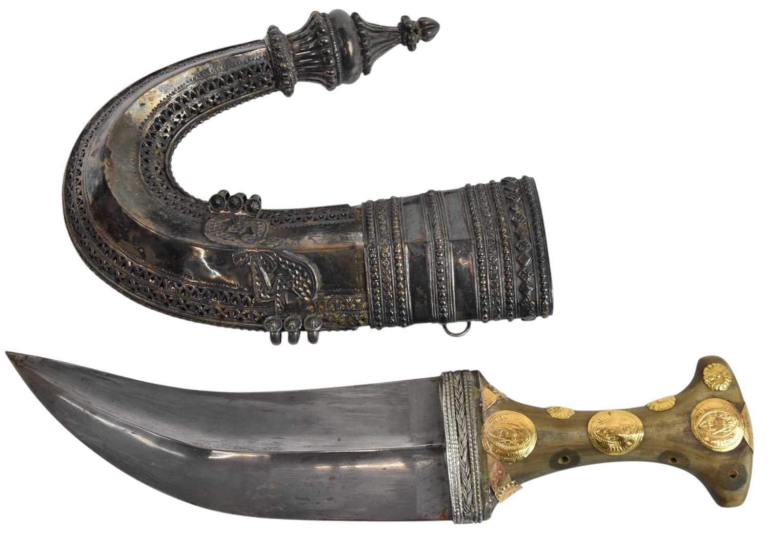 Lot 410 - An Arabian Jambiya dagger, with white metal