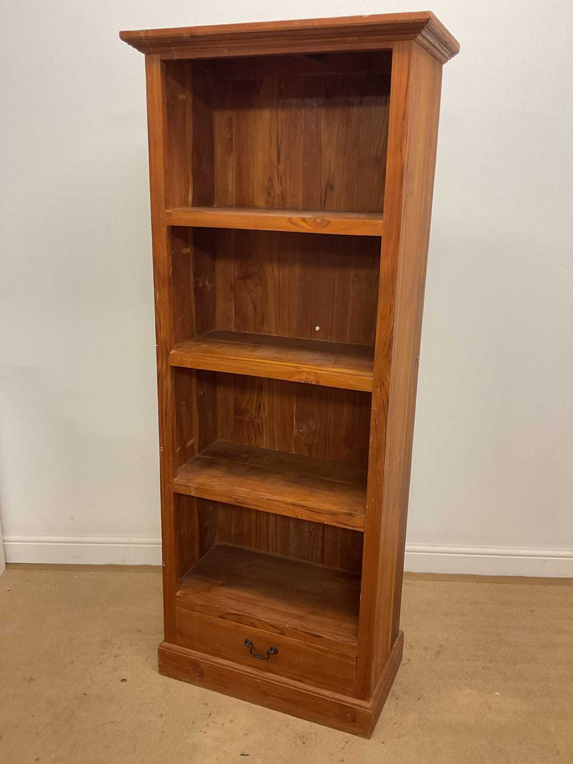 Lot 674 - A stained pine open bookcase with three
