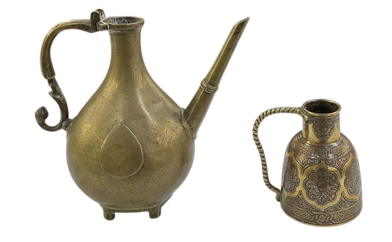 Lot 659 - An Islamic brass ewer (lacking lid), height