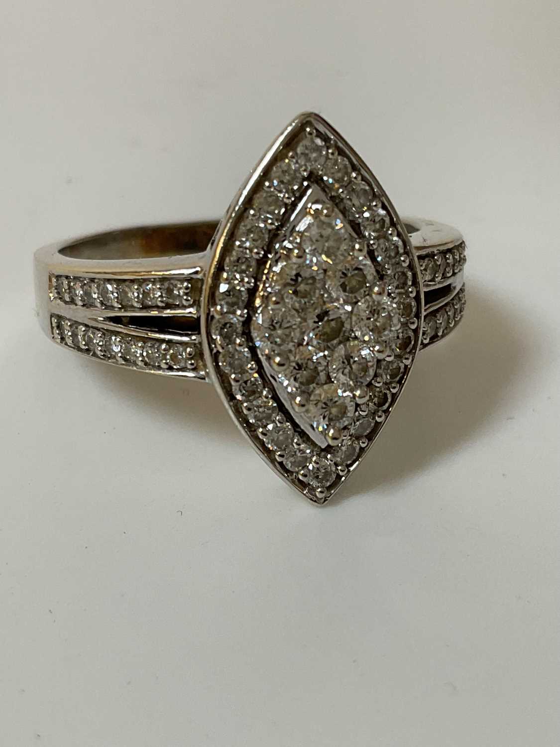 Lot 510 - A 9ct white gold and diamond lozenge shaped