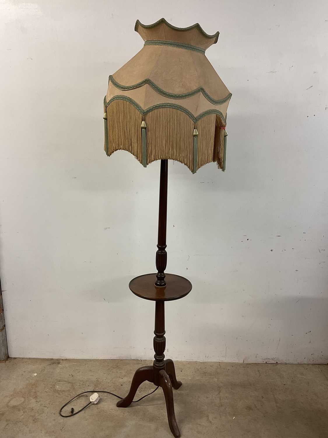 Lot 672 - A mahogany standard lamp with central dished