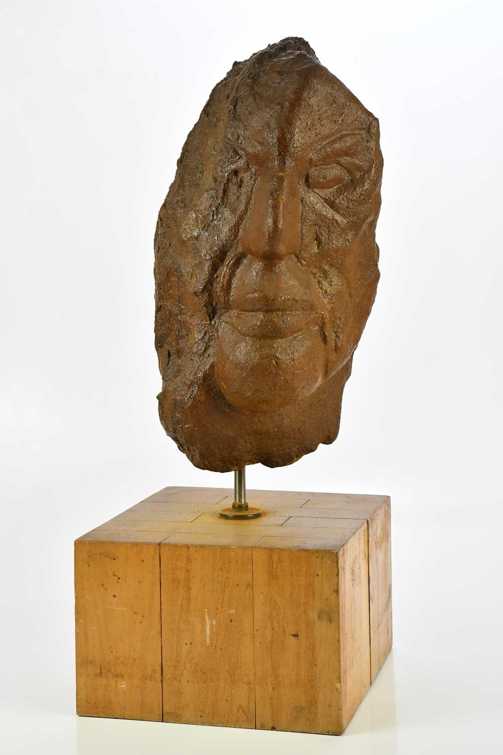 Lot 1607 - An unusual carved stone head, on wooden