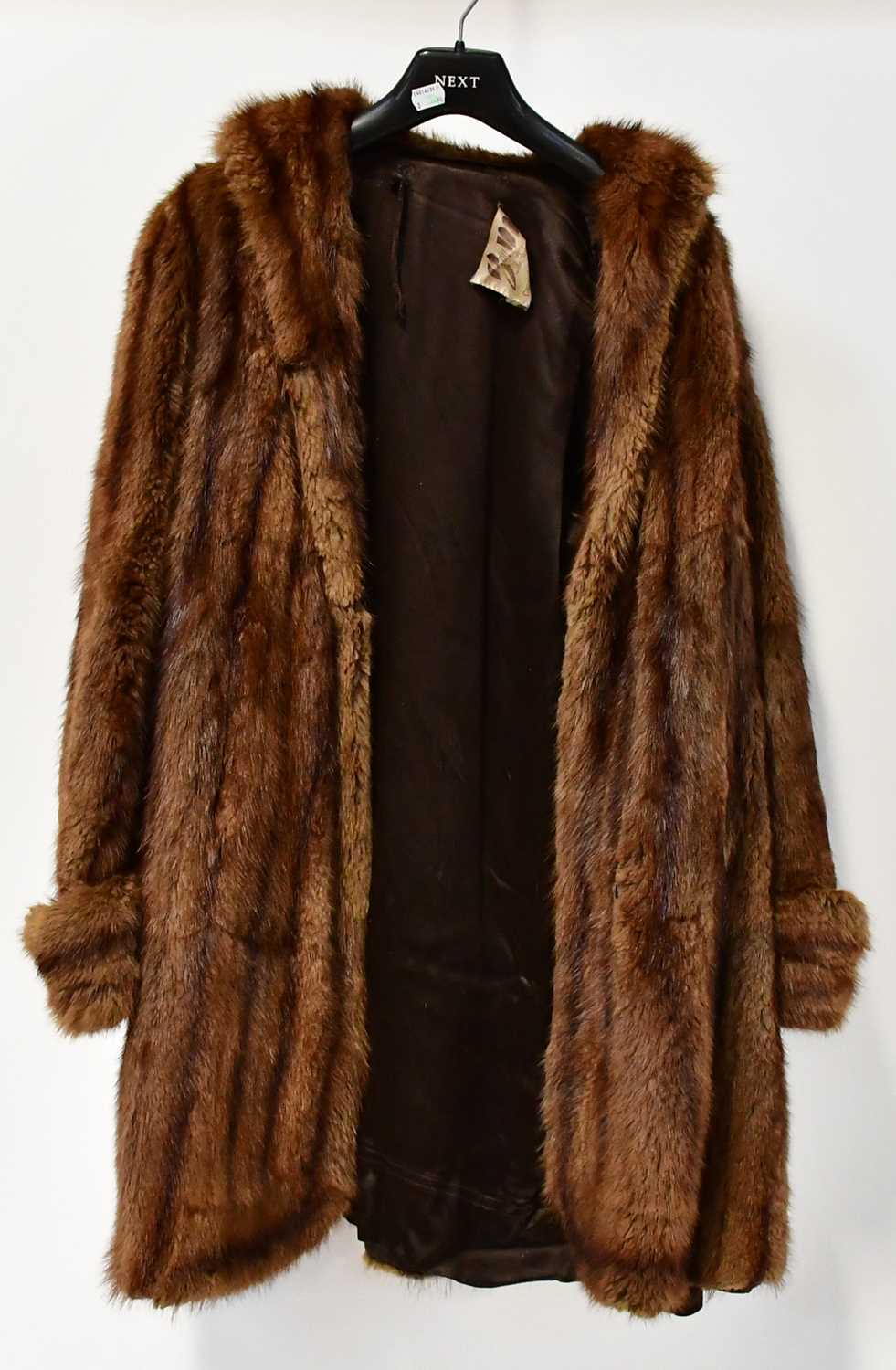 Lot 707 - A fur coat bearing label for 'Bon Marché,