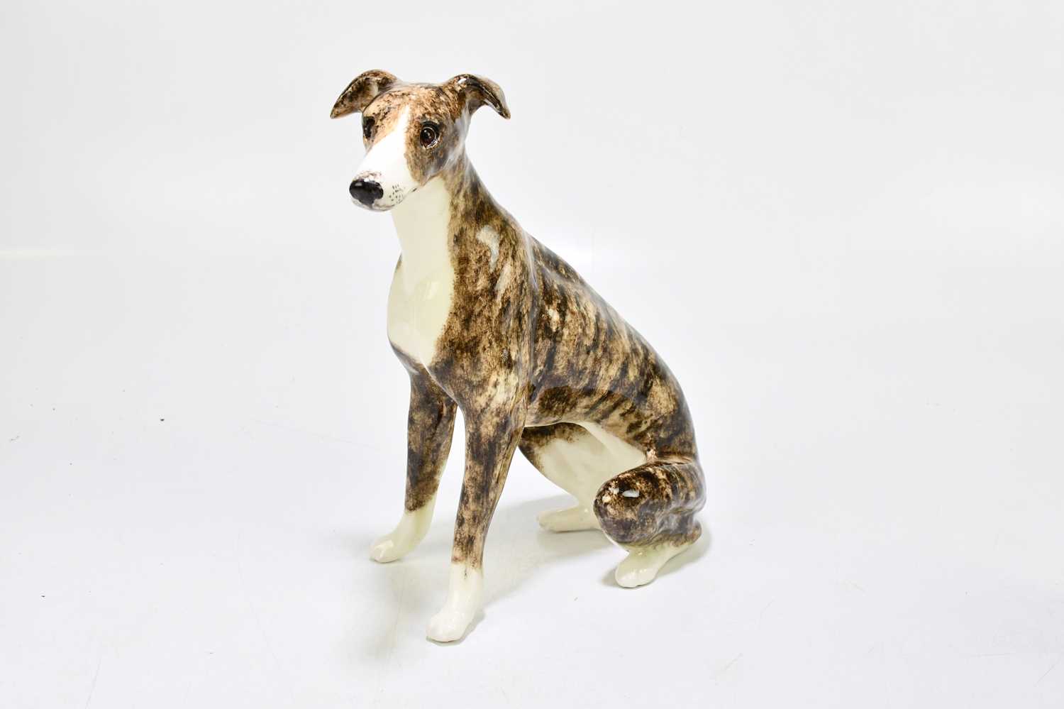 Lot 545 - WINSTANLEY; a model of a seated dog, height