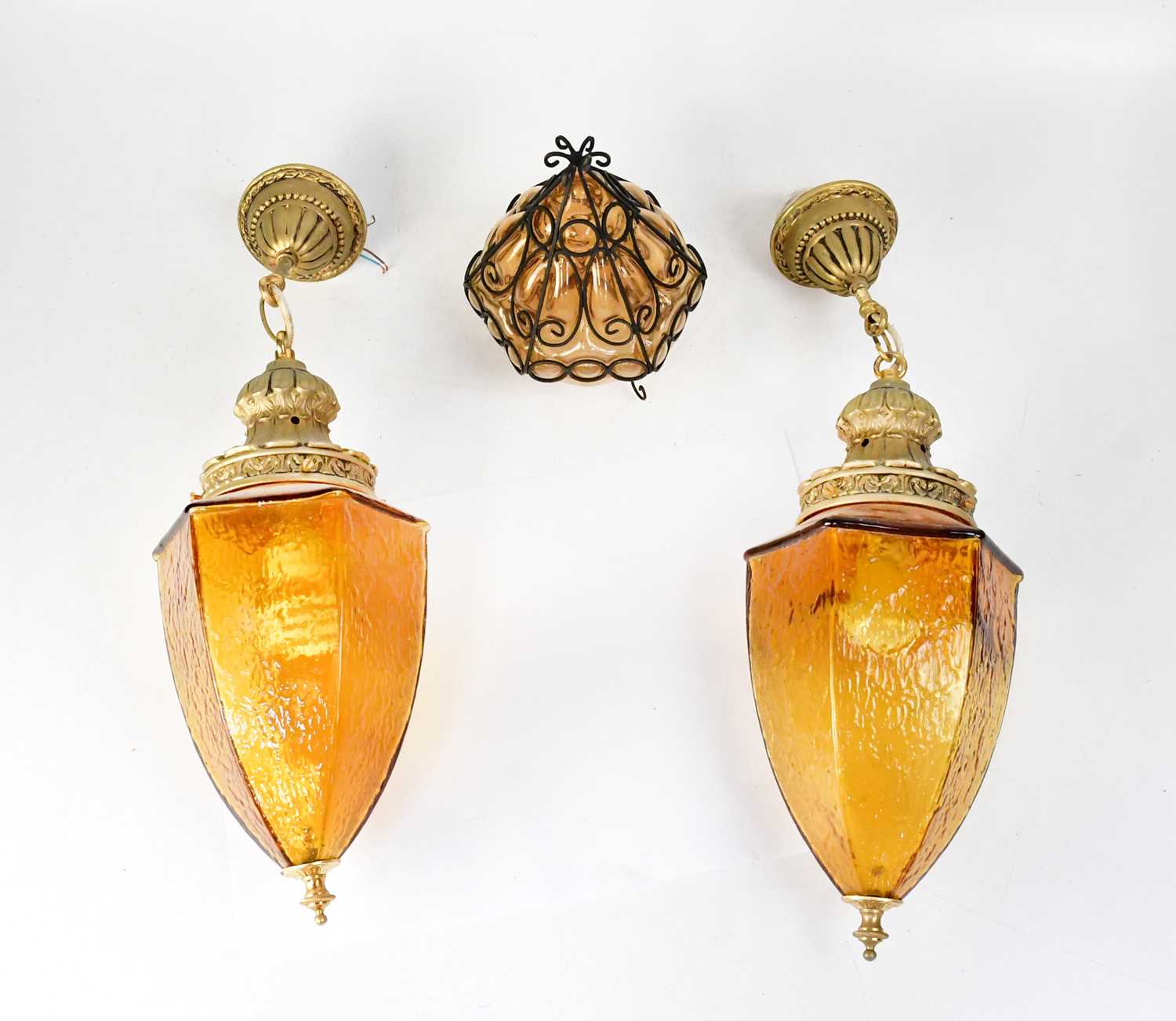Lot 143 - A pair of amber glass ceiling pendant lights,