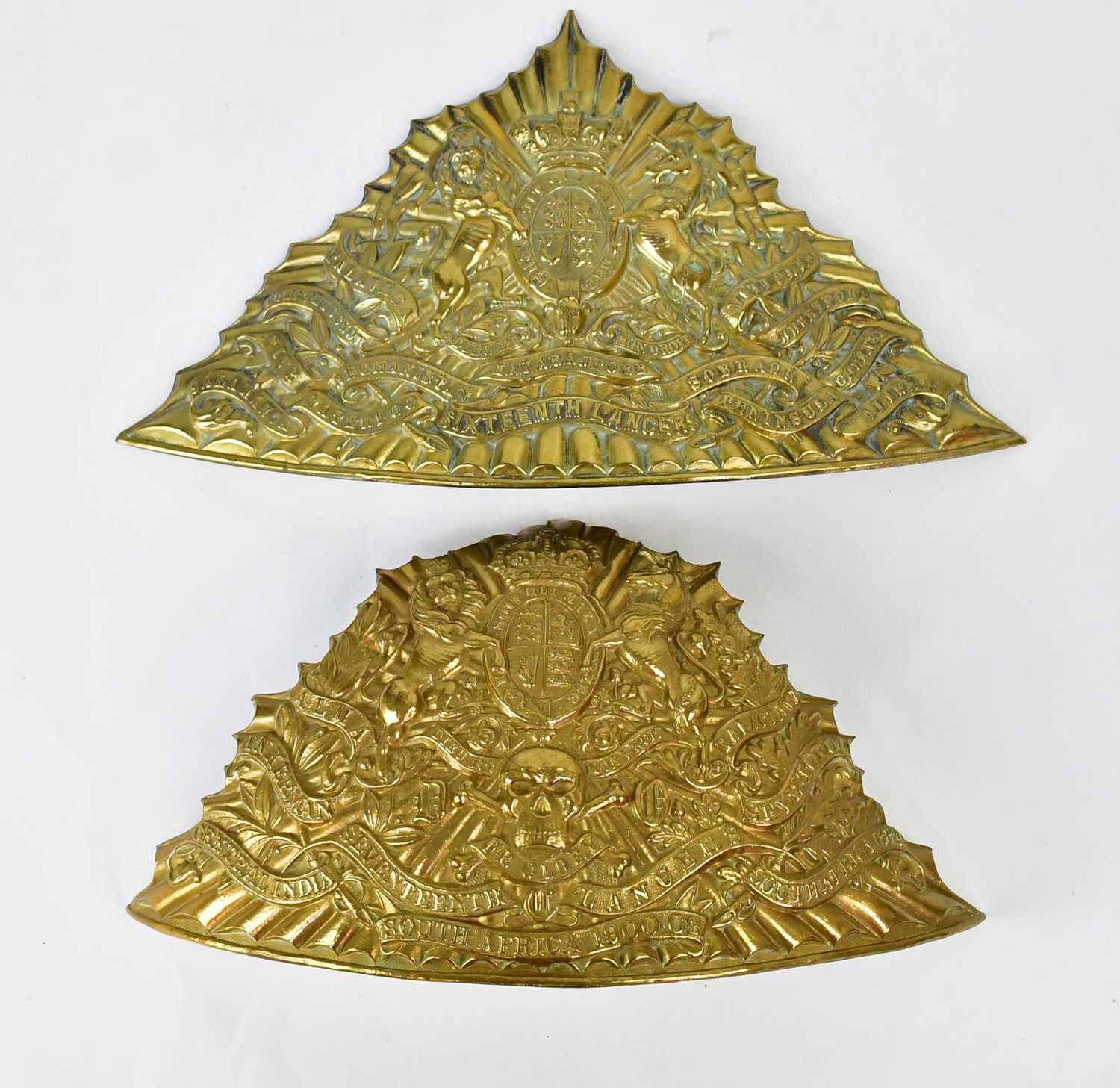 Lot 469 - Two pressed brass helmet plates for the