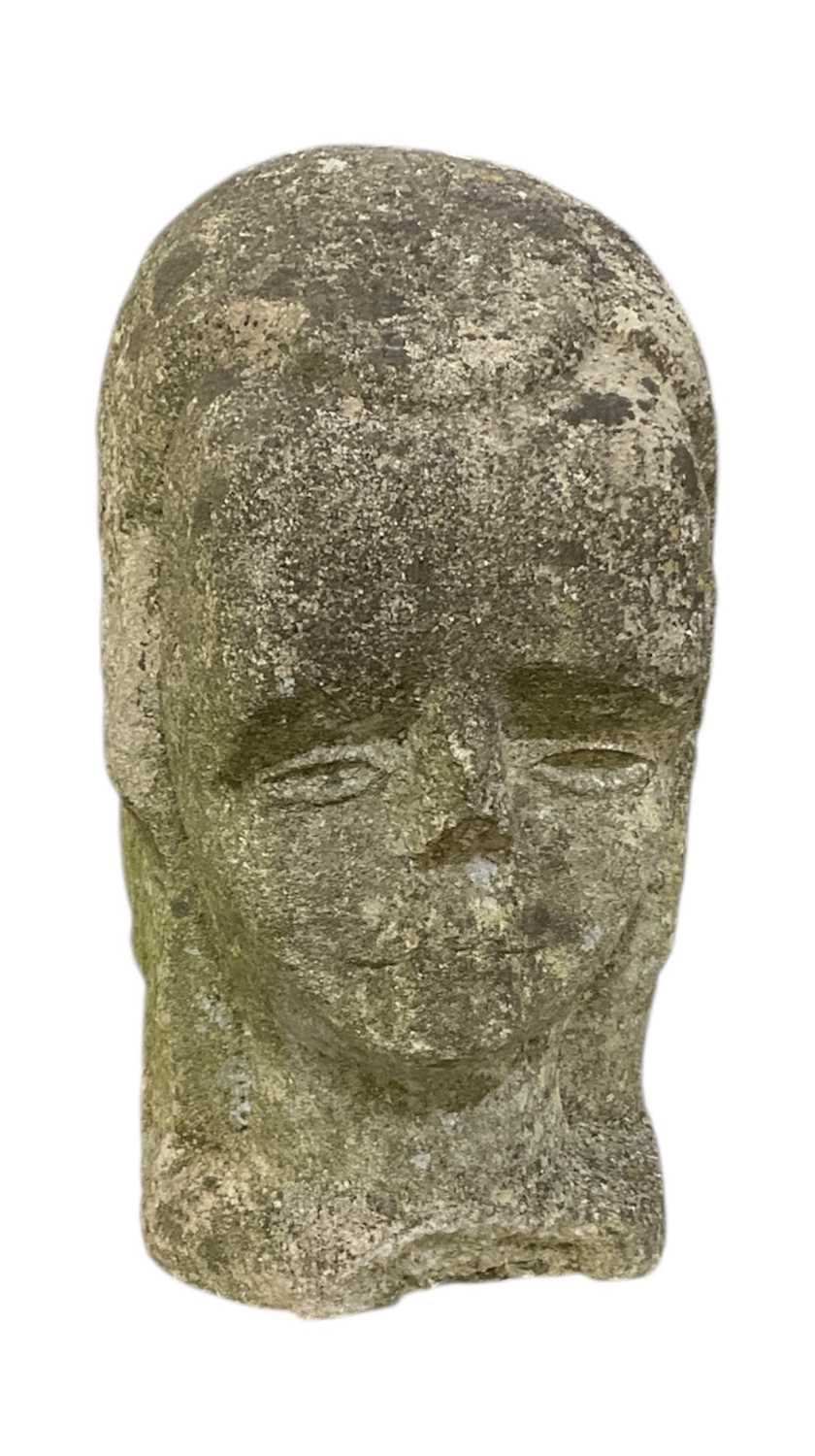 Lot 649 - A carved reconstituted stone head, height
