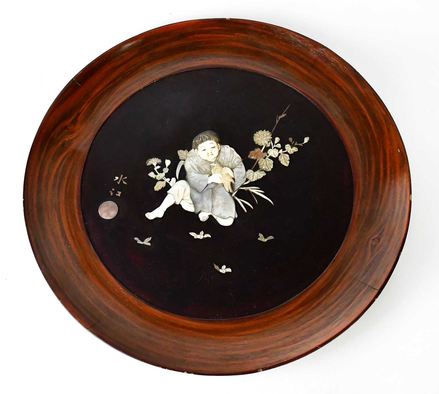 Lot 180 - A Japanese Shibayama roundel depicting a boy
