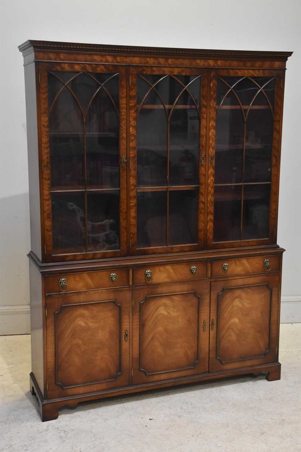 Lot 136 - A large reproduction mahogany bookcase, with