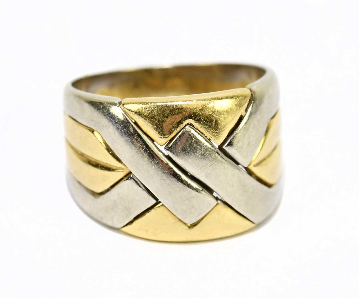 Lot 1063 - An 18ct yellow and white gold broad ring,