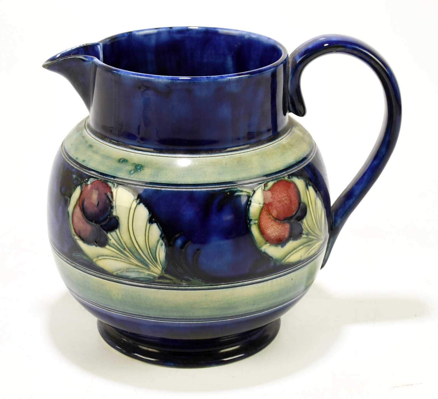 Lot 28 - WILLIAM MOORCROFT; a bulbous jug decorated in