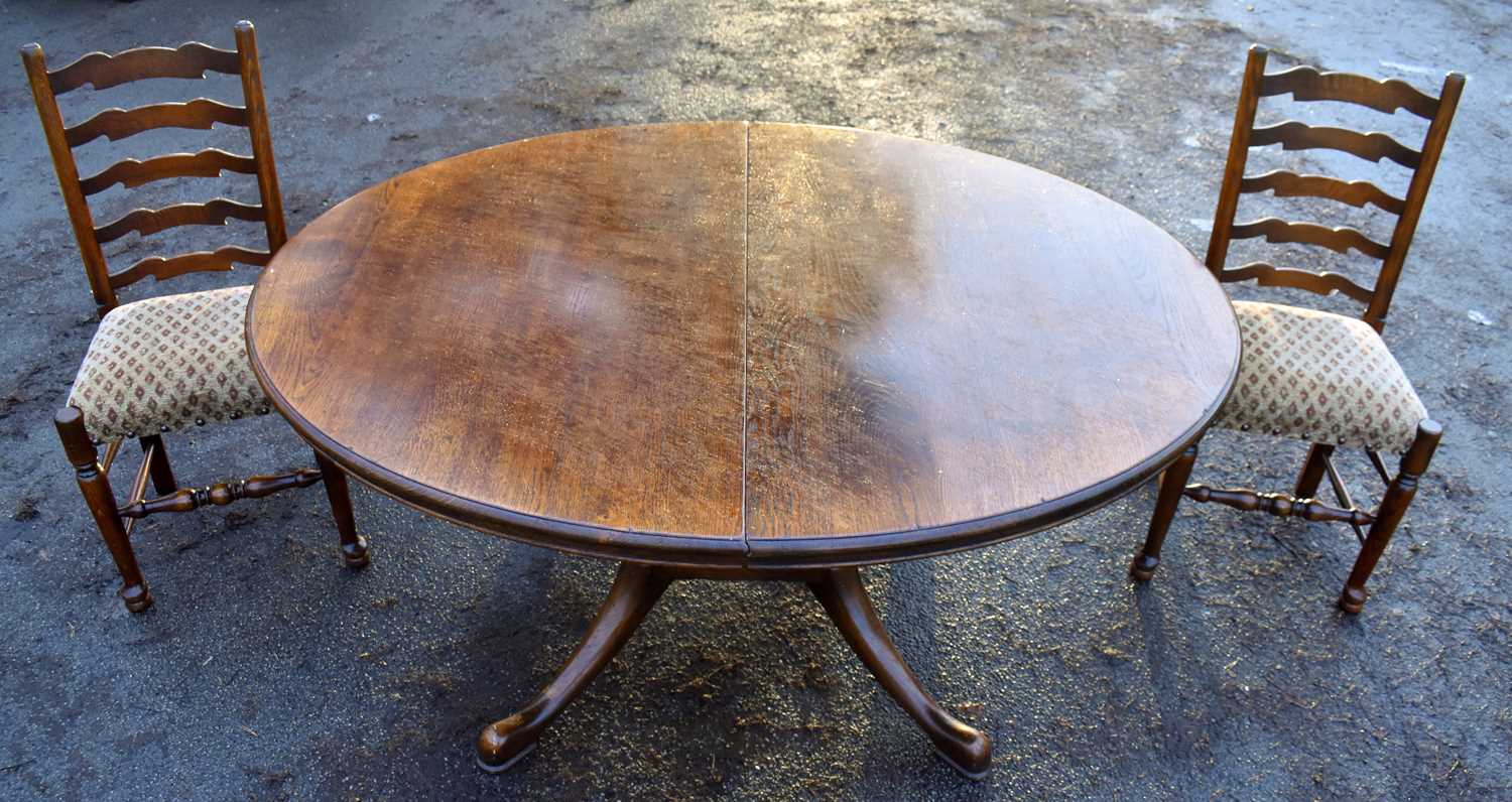 Lot 1725 - A reproduction oak oval extending dining