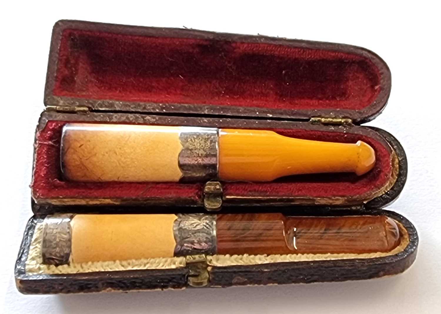 Lot 178 - Two cased amber cheroot/cigarette holders,