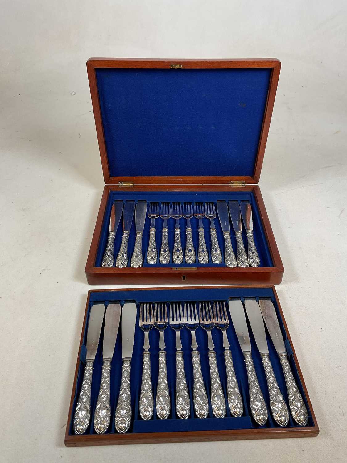 Lot 429 - A walnut cased set of silver plated fish