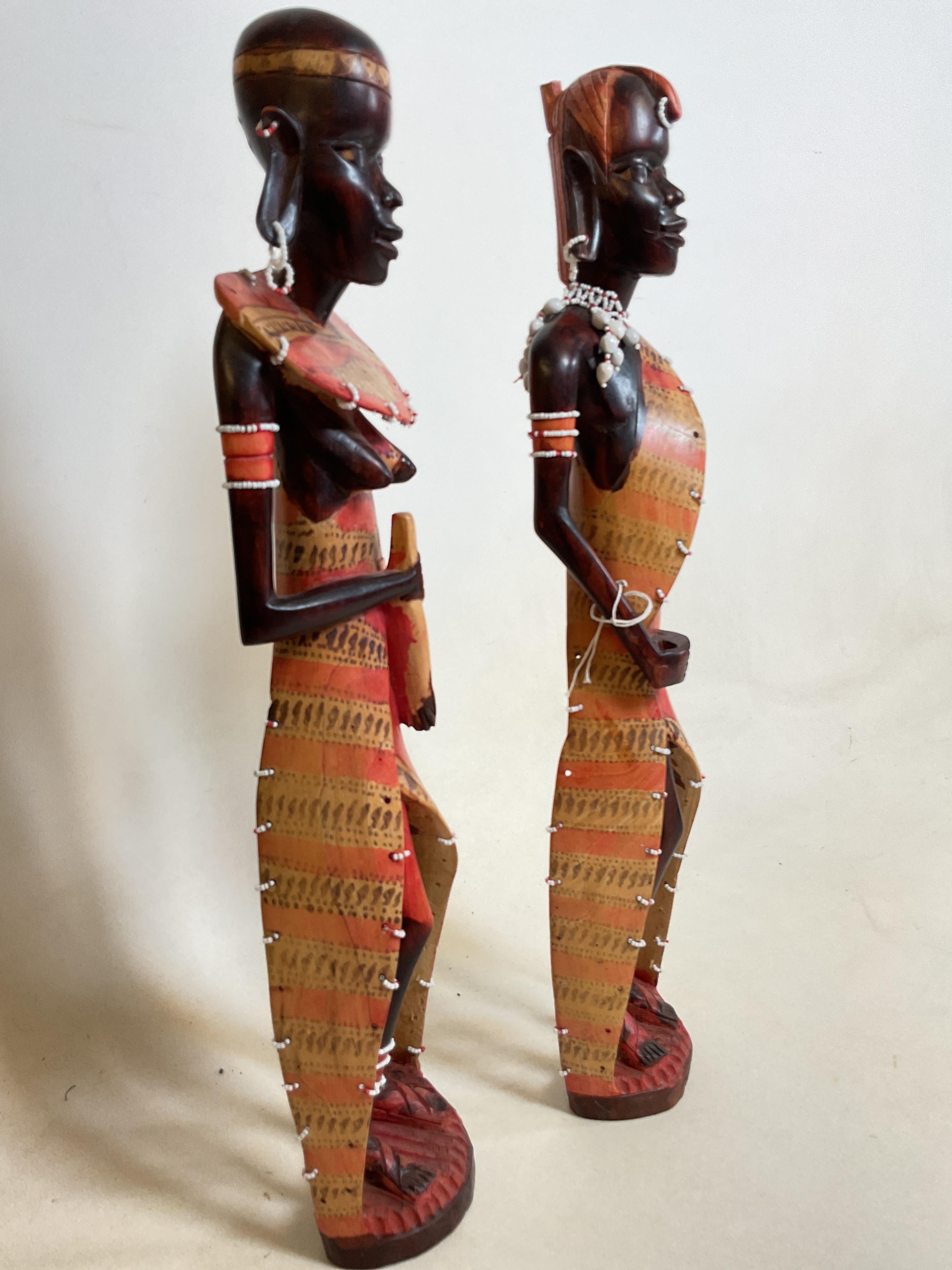 Lot 24 - A pair of tall African tribal figures.