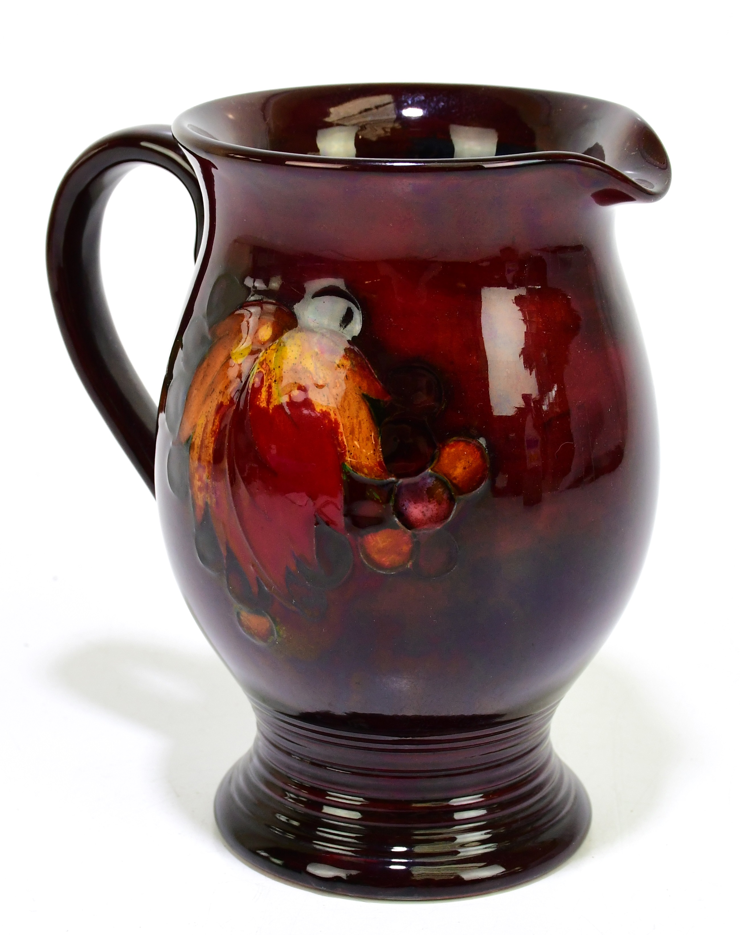 Lot 23 - WILLIAM MOORCROFT; a jug with ribbed foot rim,