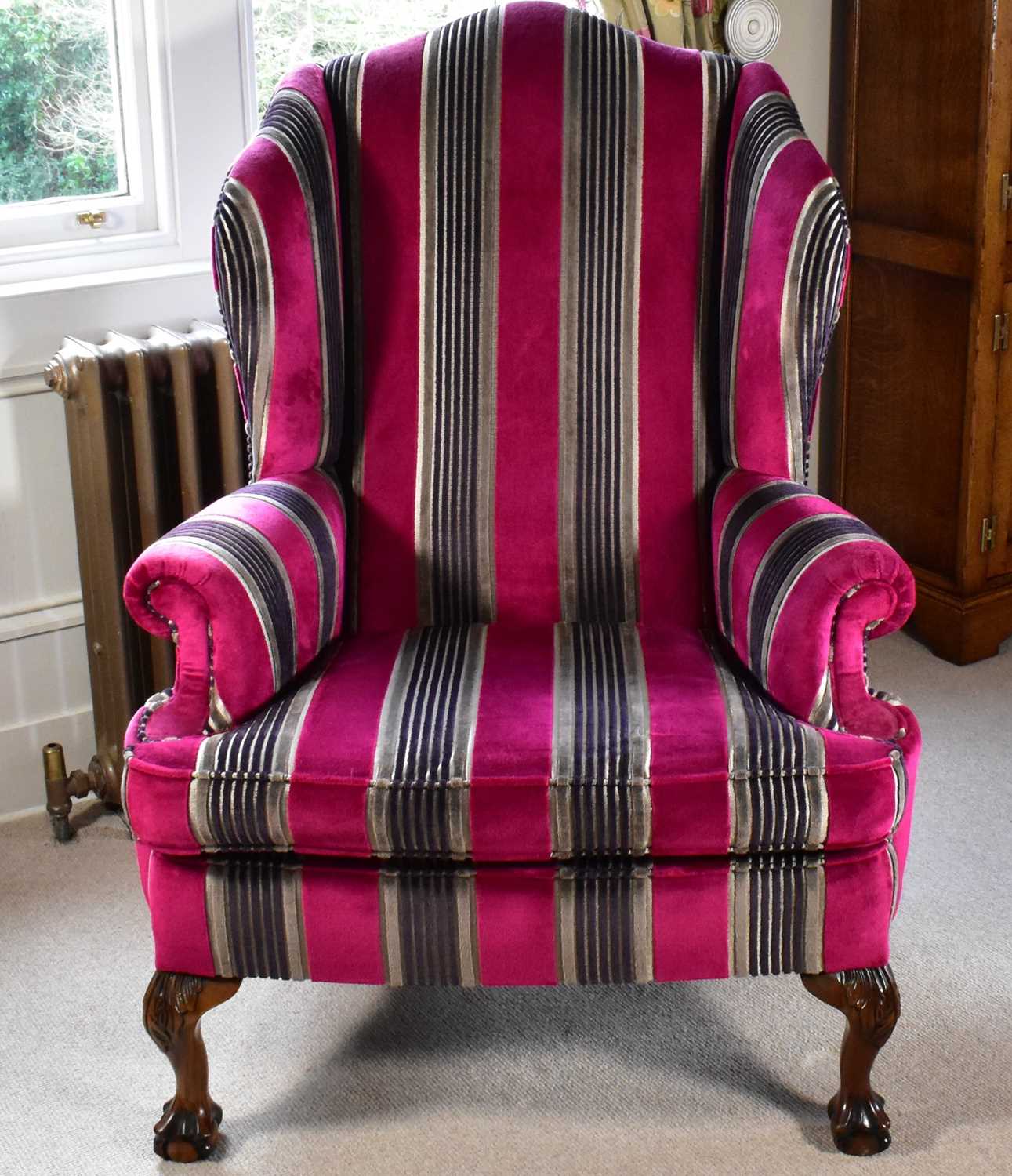 Lot 2922 - A reproduction wing back armchair with