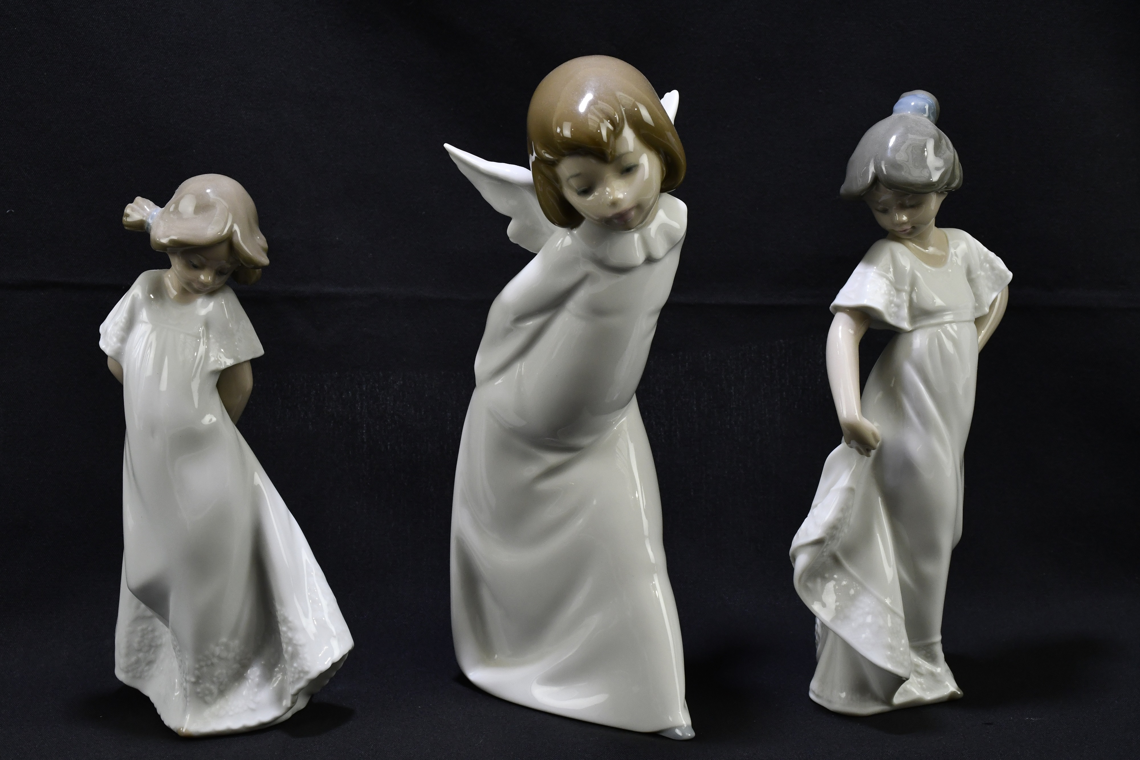 Lot 638 - LLADRO; three ceramic figures of angels,