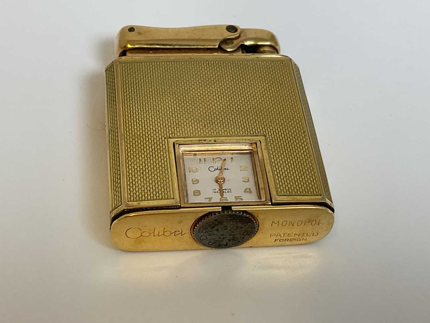 Lot 584 - COLIBRI; a 9ct gold cased 'Monopol' lighter