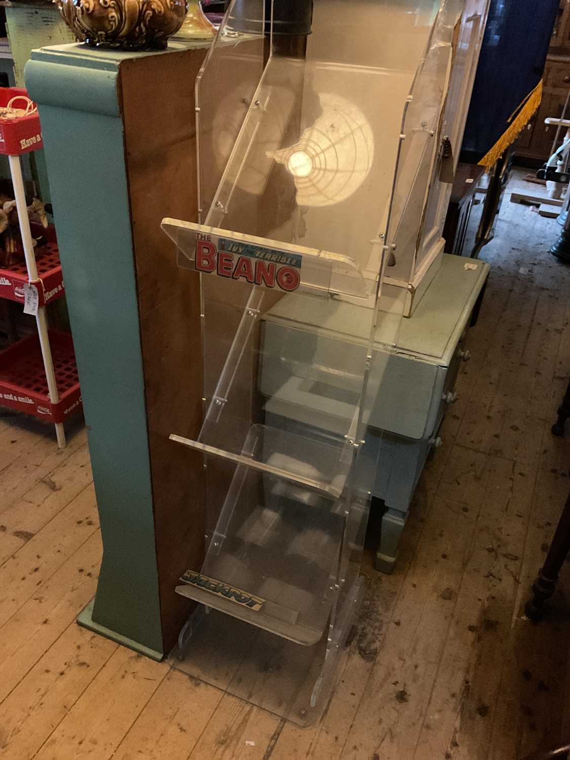 Lot 399 - A perspex three tier magazine display shelf,