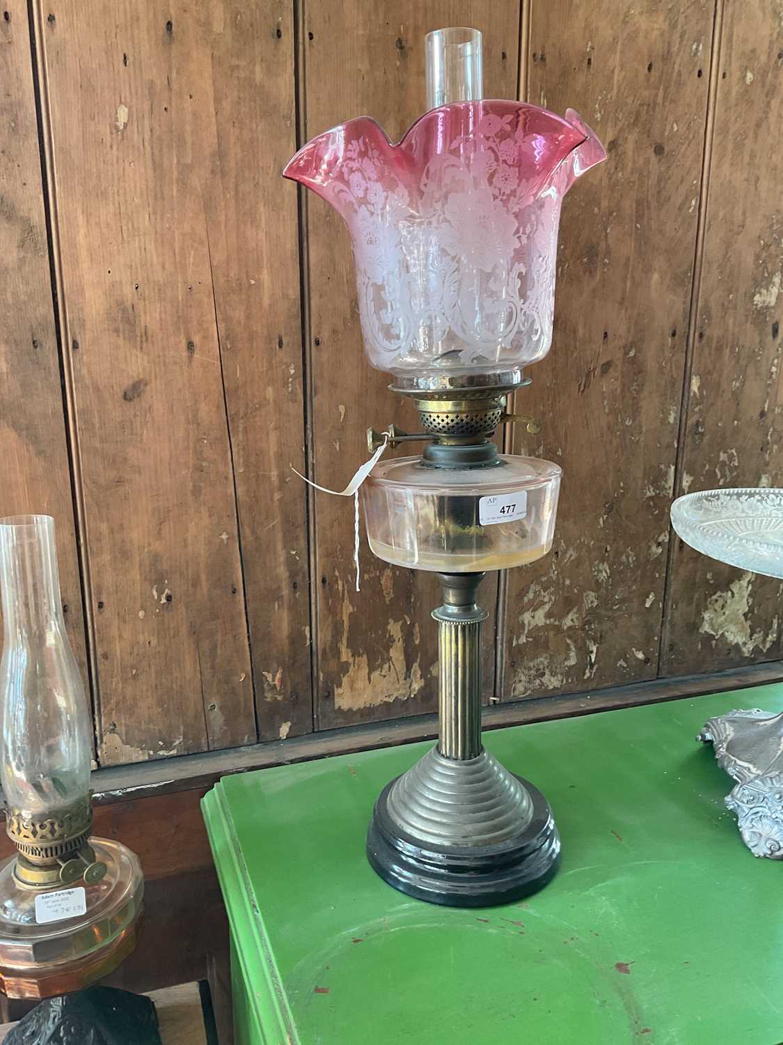 Lot 477 - A late Victorian oil lamp with cranberry and