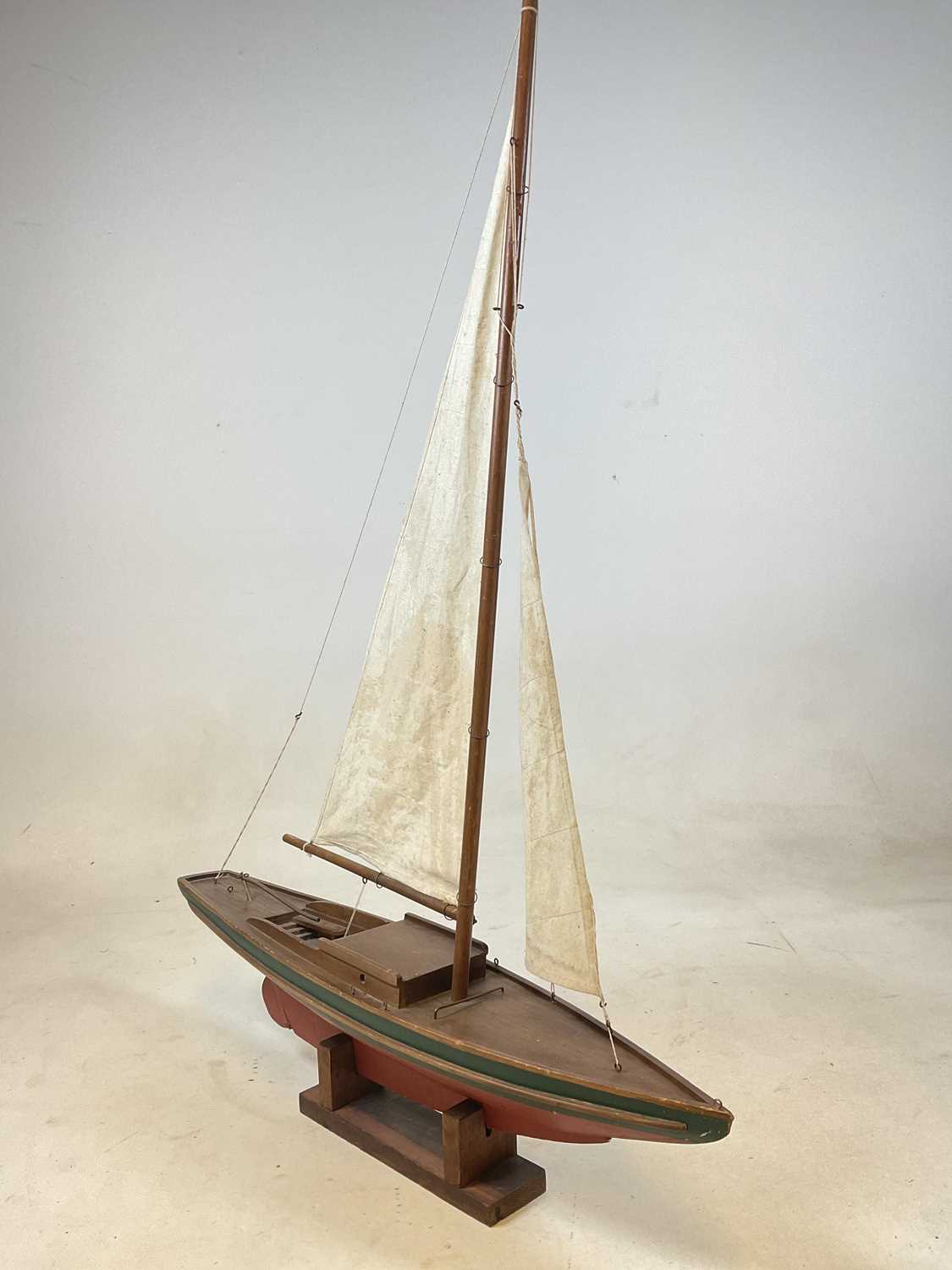 Lot 62 - A vintage wooden pond yacht with linen sails,