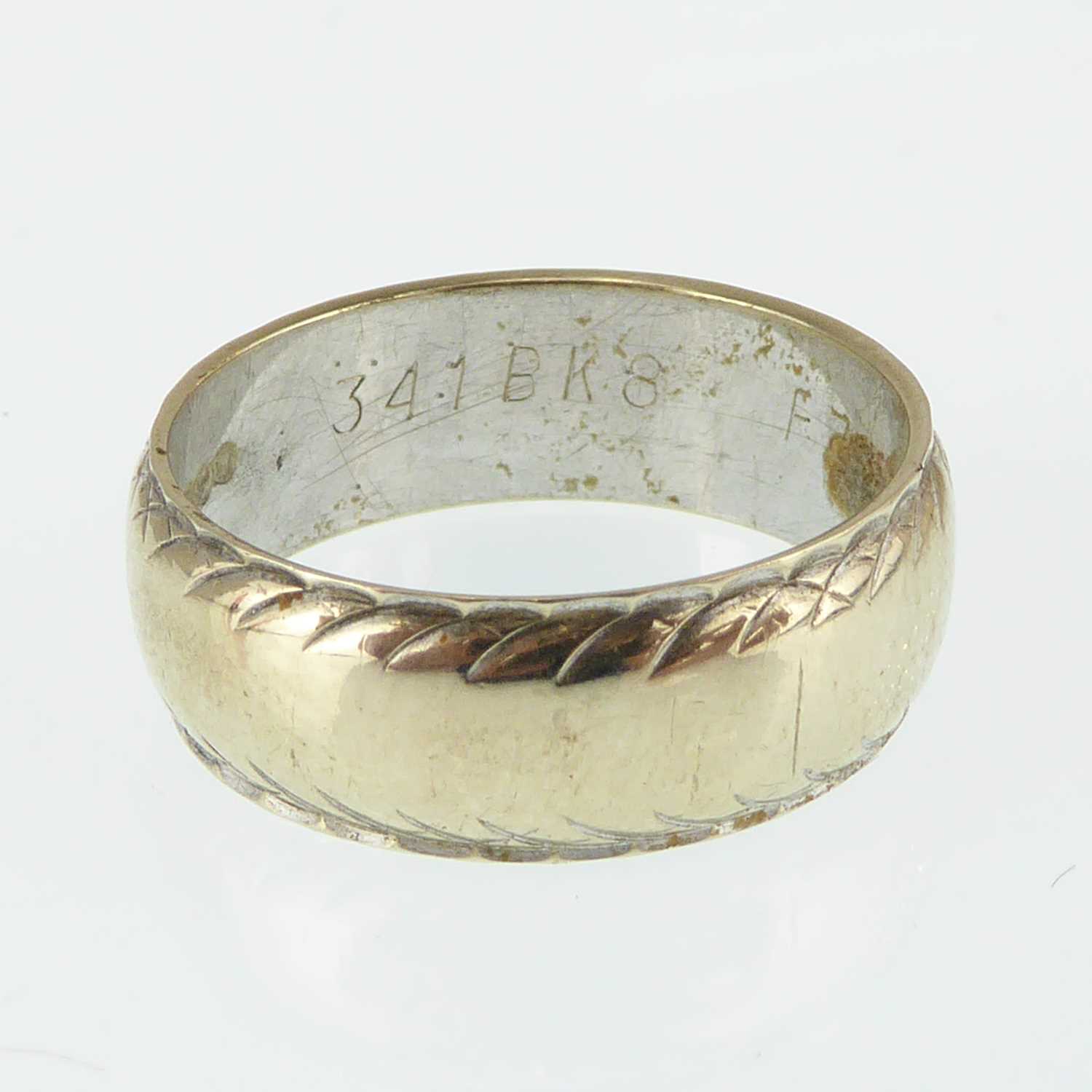 Lot 1107 - A 9ct white gold band ring with serrated