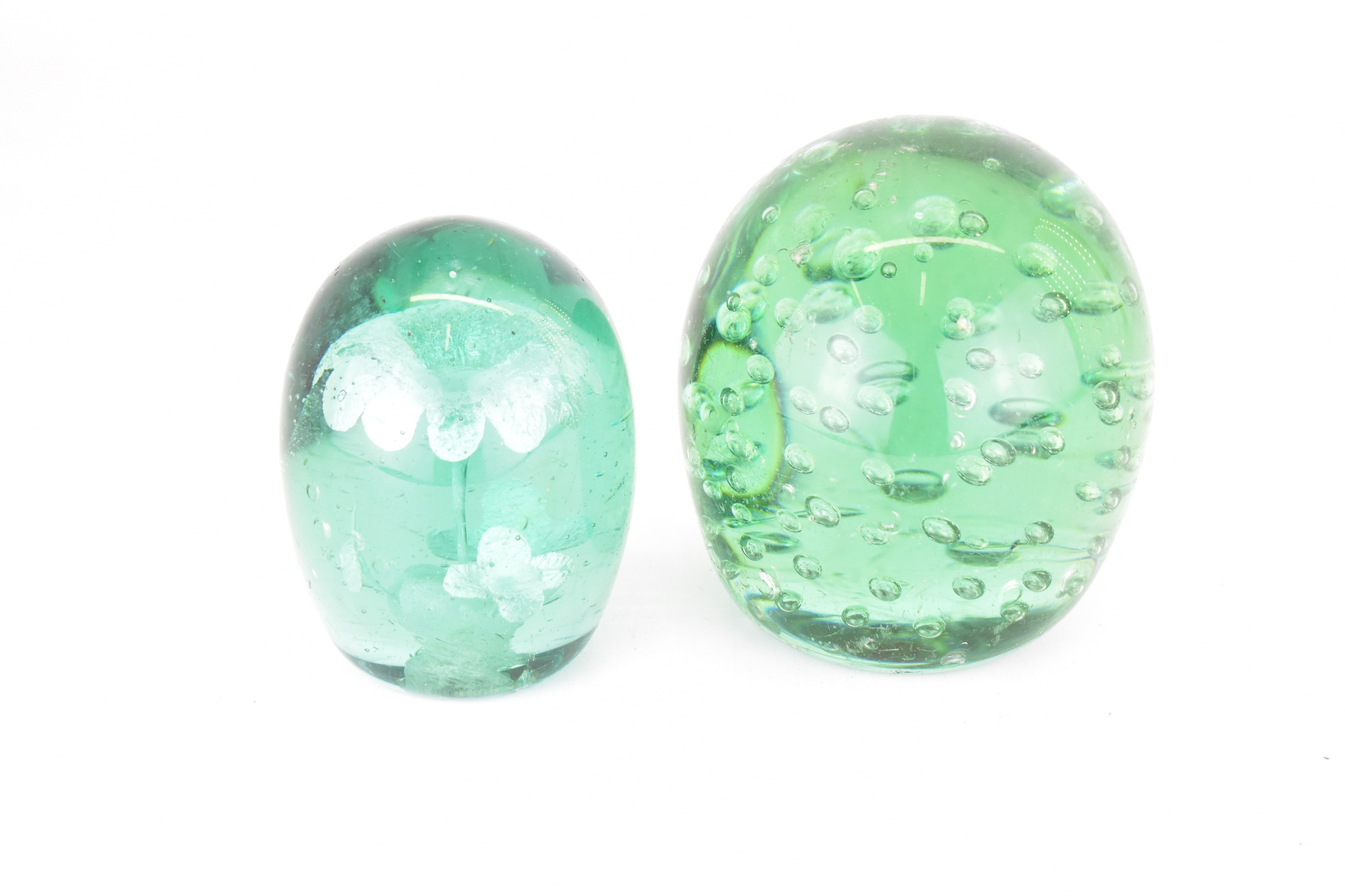 Lot 568 - Two Victorian green glass dump paperweights,