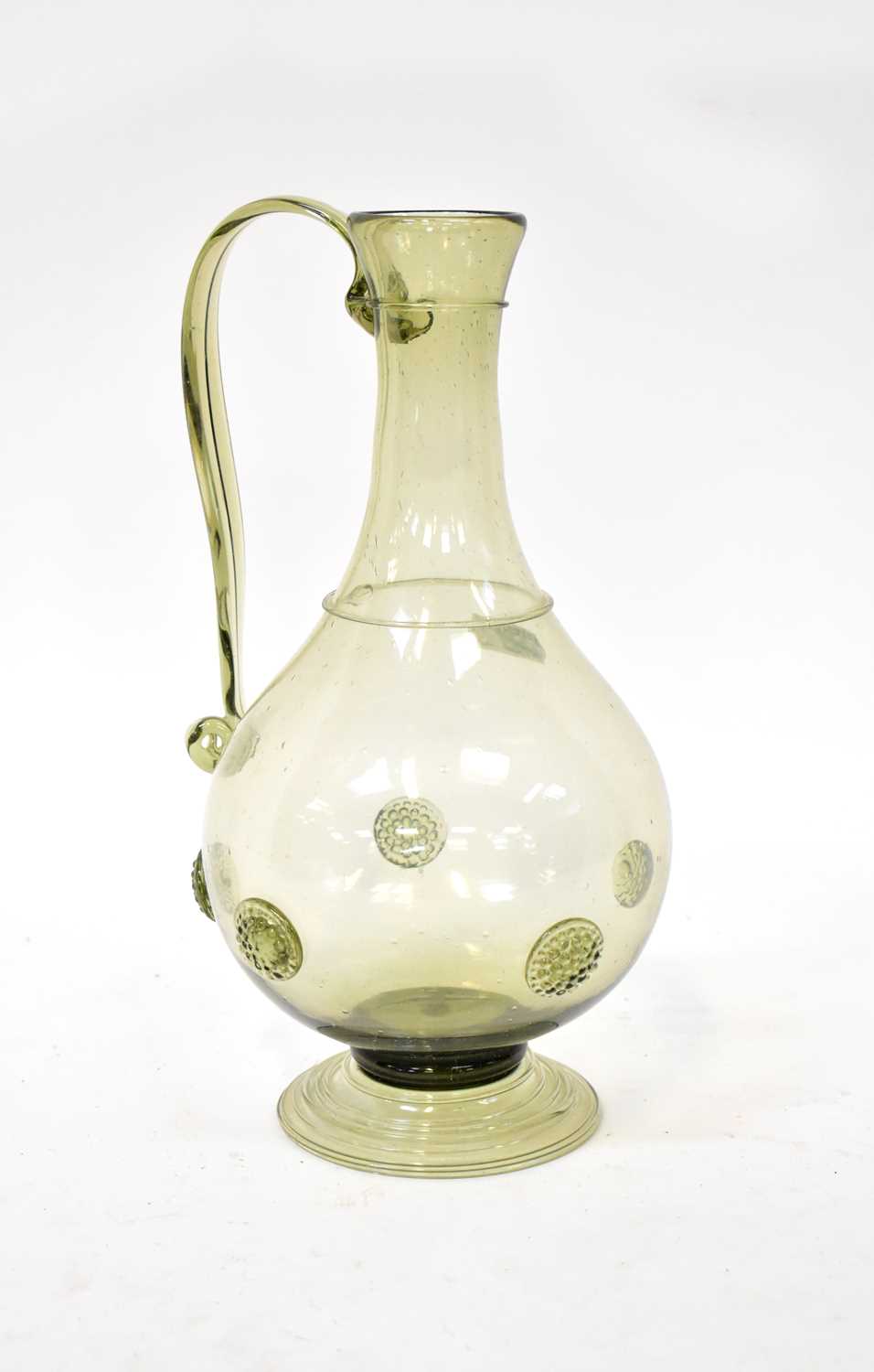 Lot 569 - A 19th century pale green glass jug with