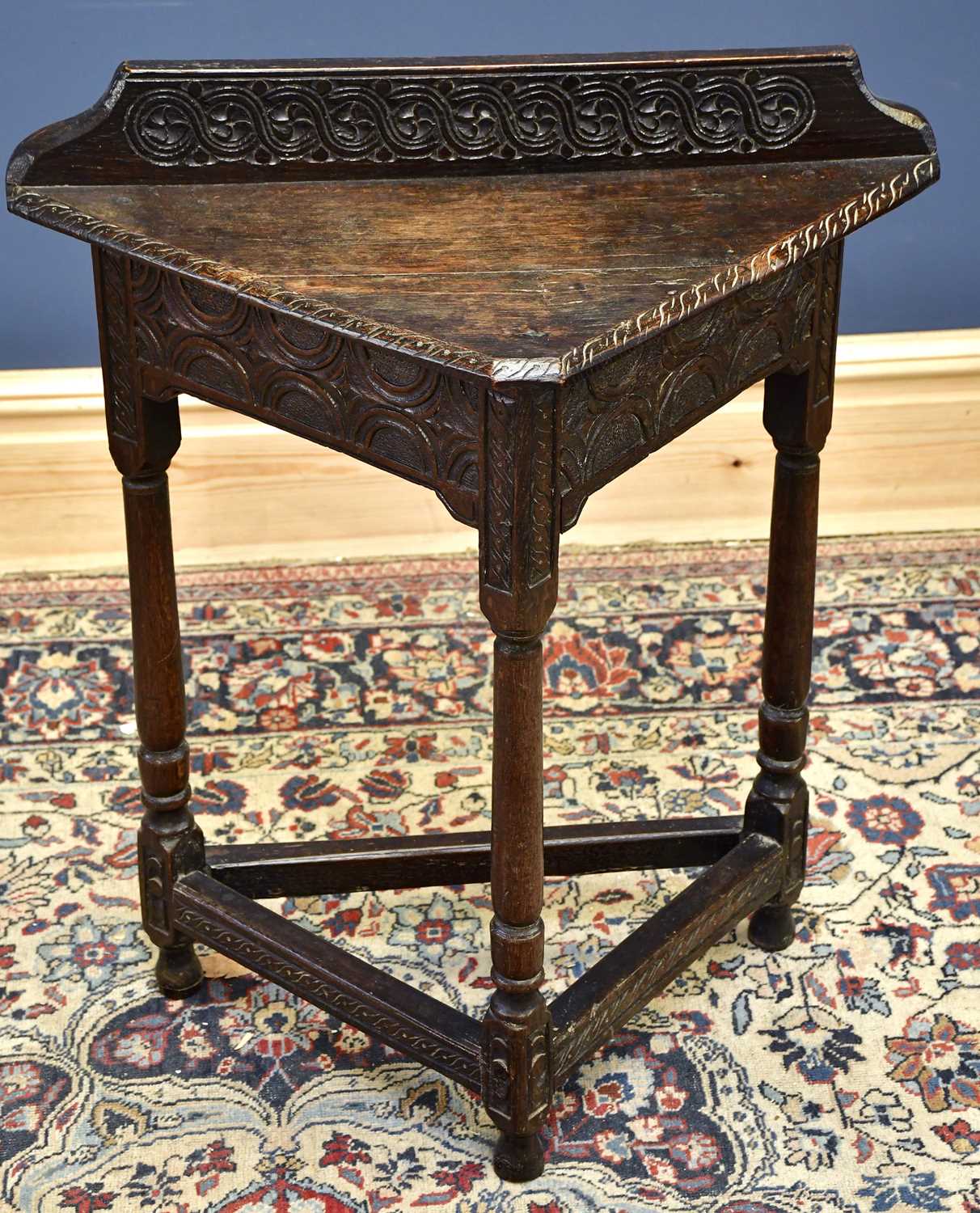 Lot 1678 - A late Victorian carved oak triangular