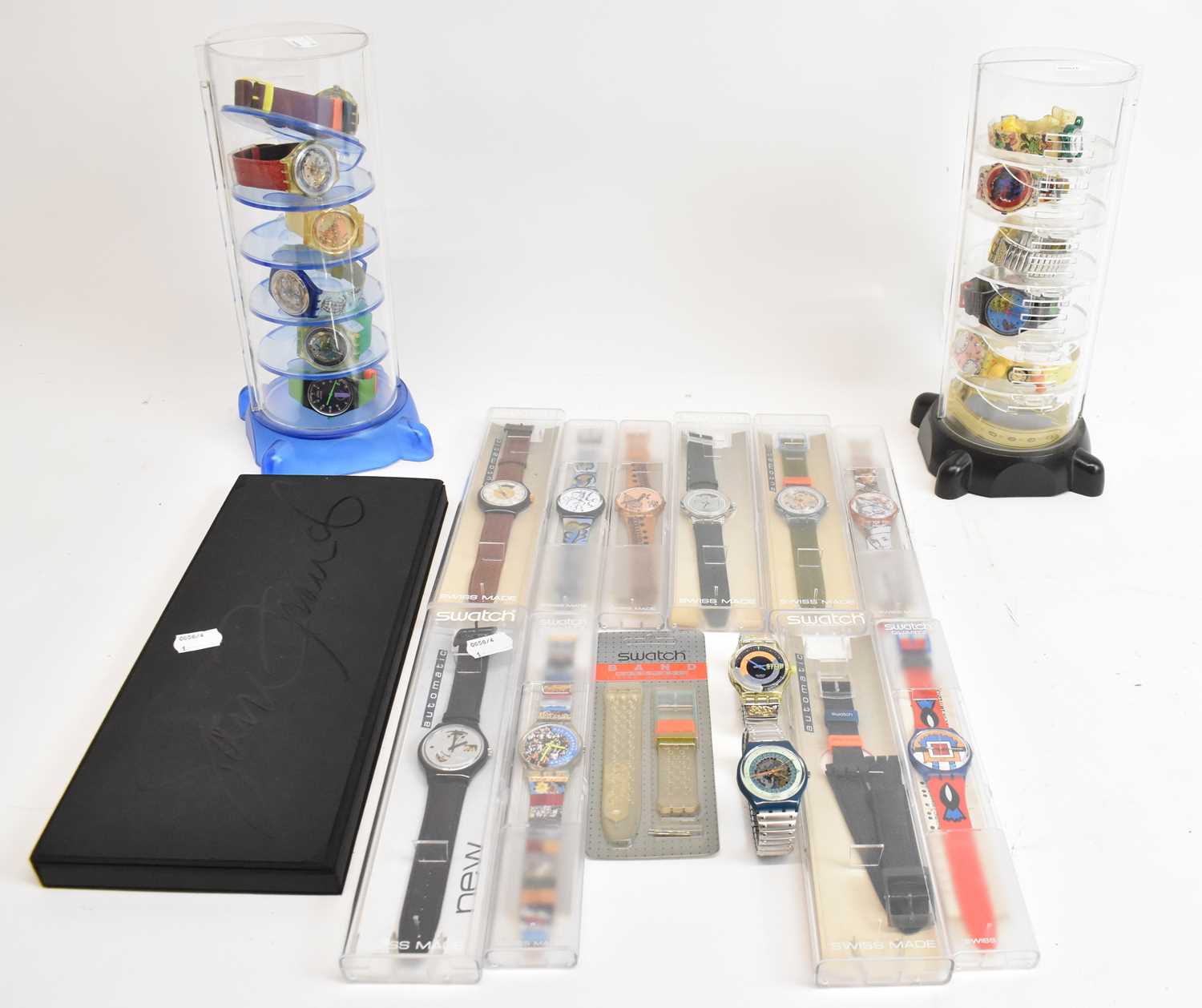 Lot 678 - SWATCH; two perspex towers containing twelve