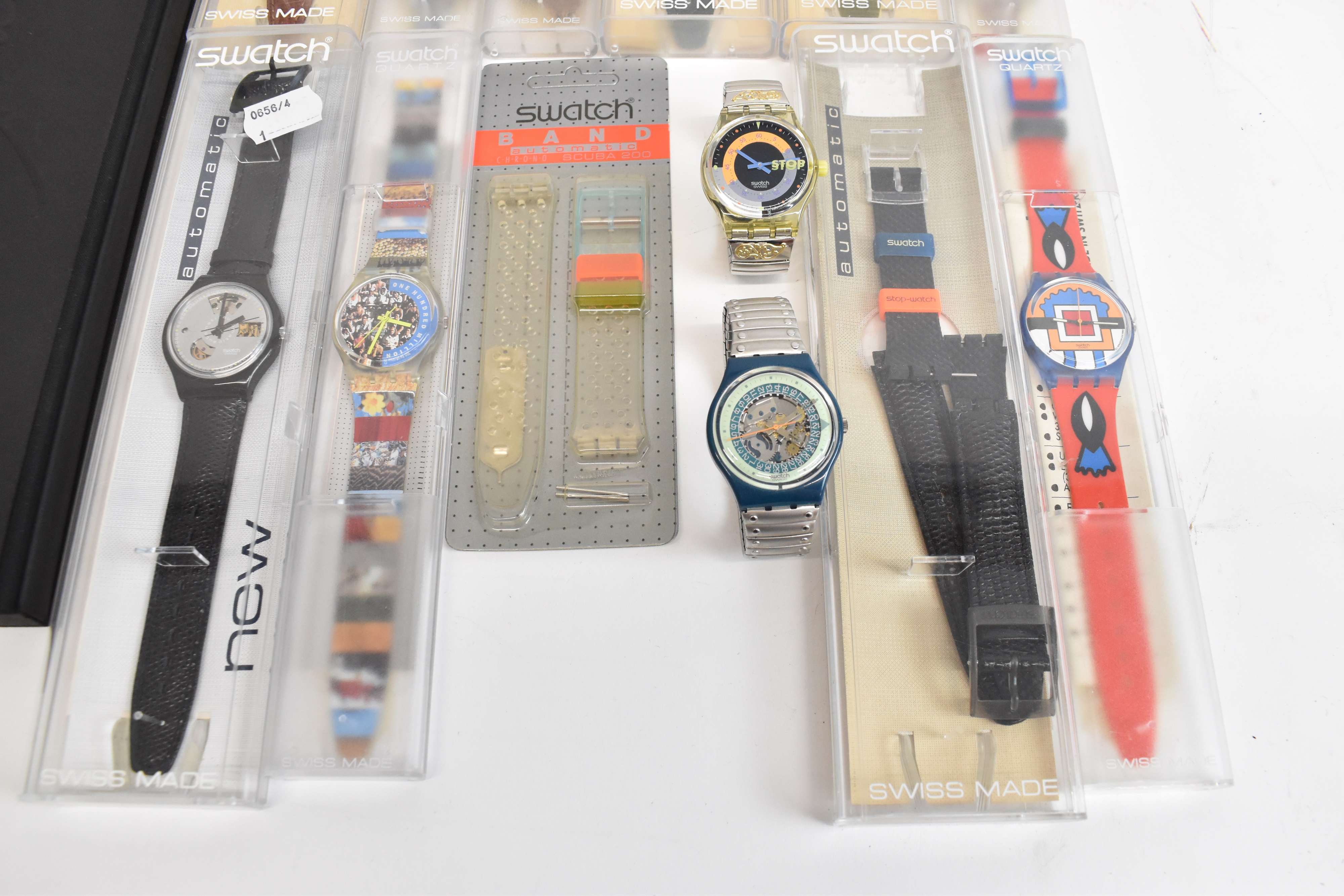 Lot 678 - SWATCH; two perspex towers containing twelve