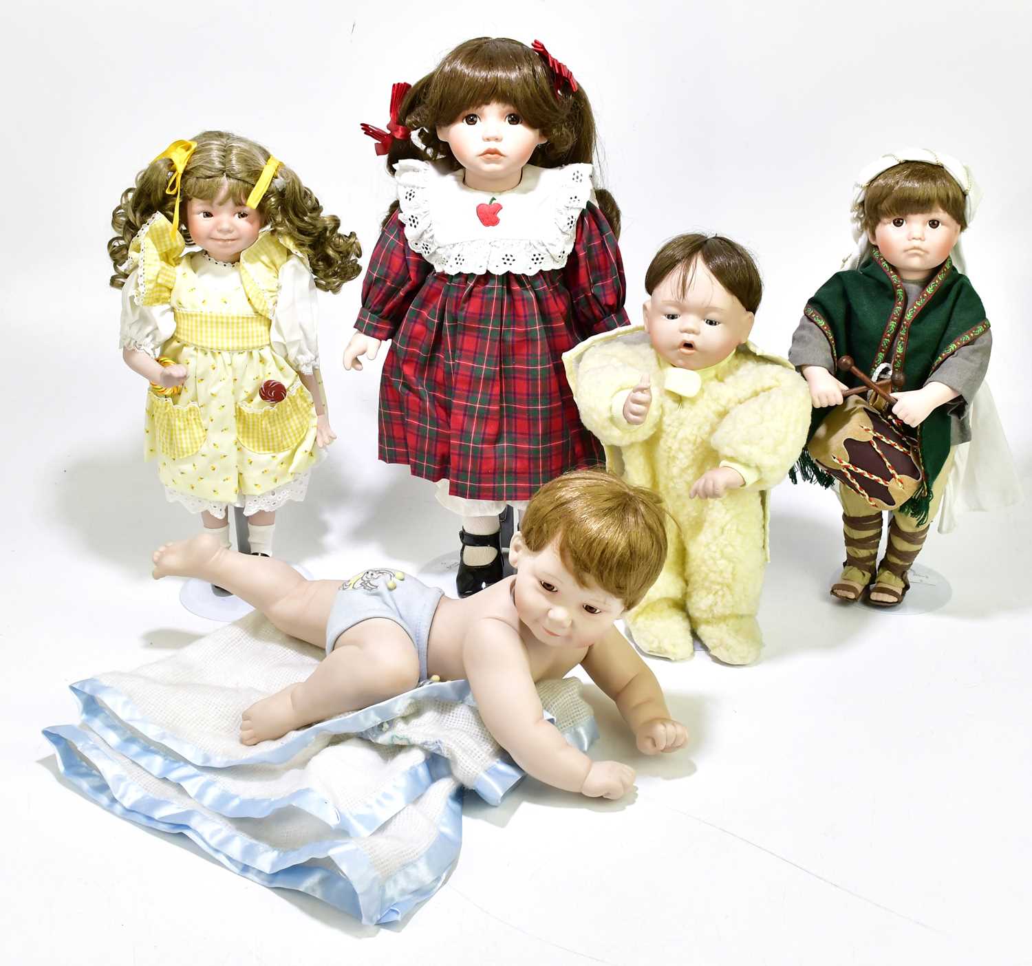 Lot 302 - A group of five porcelain dolls, height of