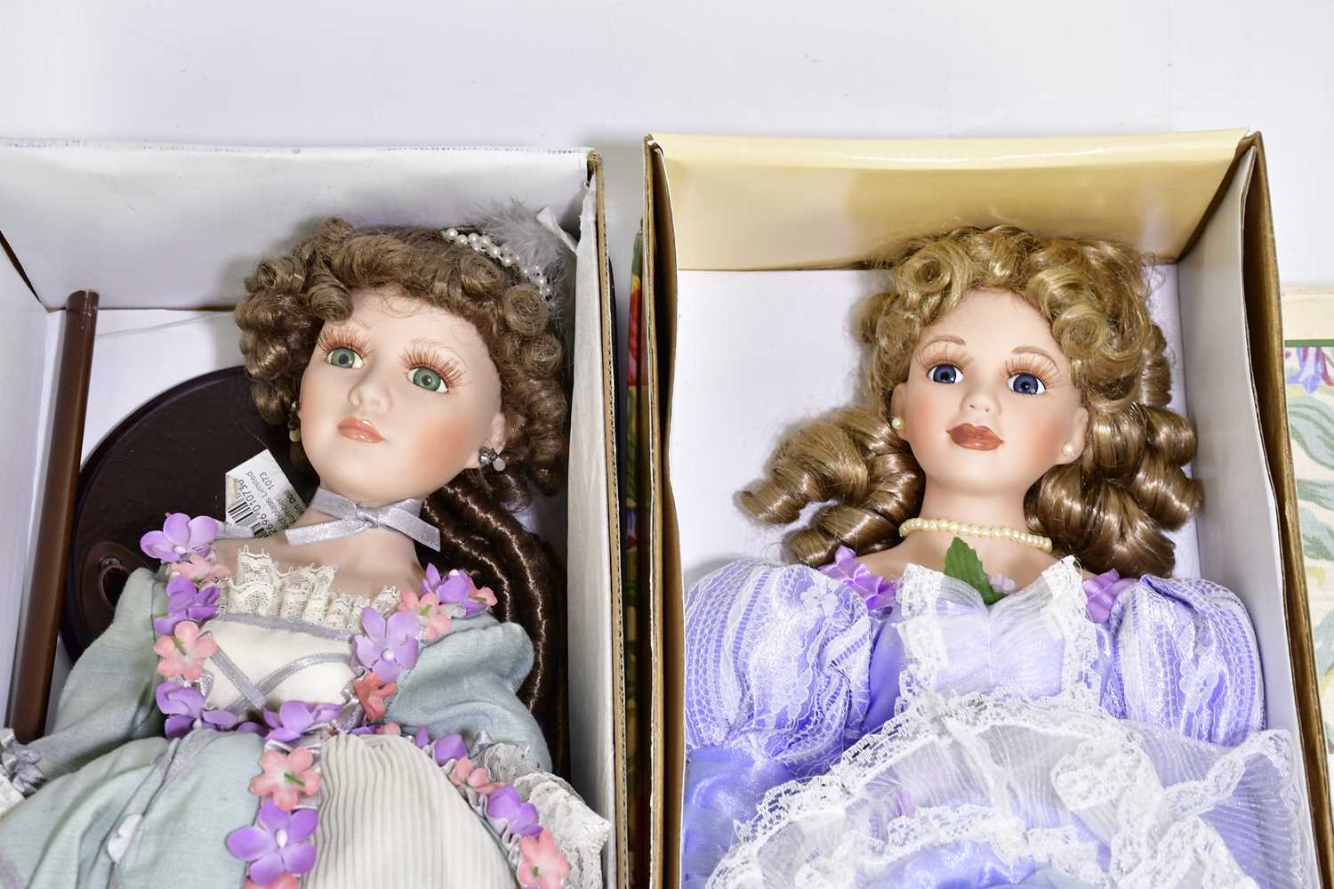 Lot 305 - A group of five boxed porcelain dolls to