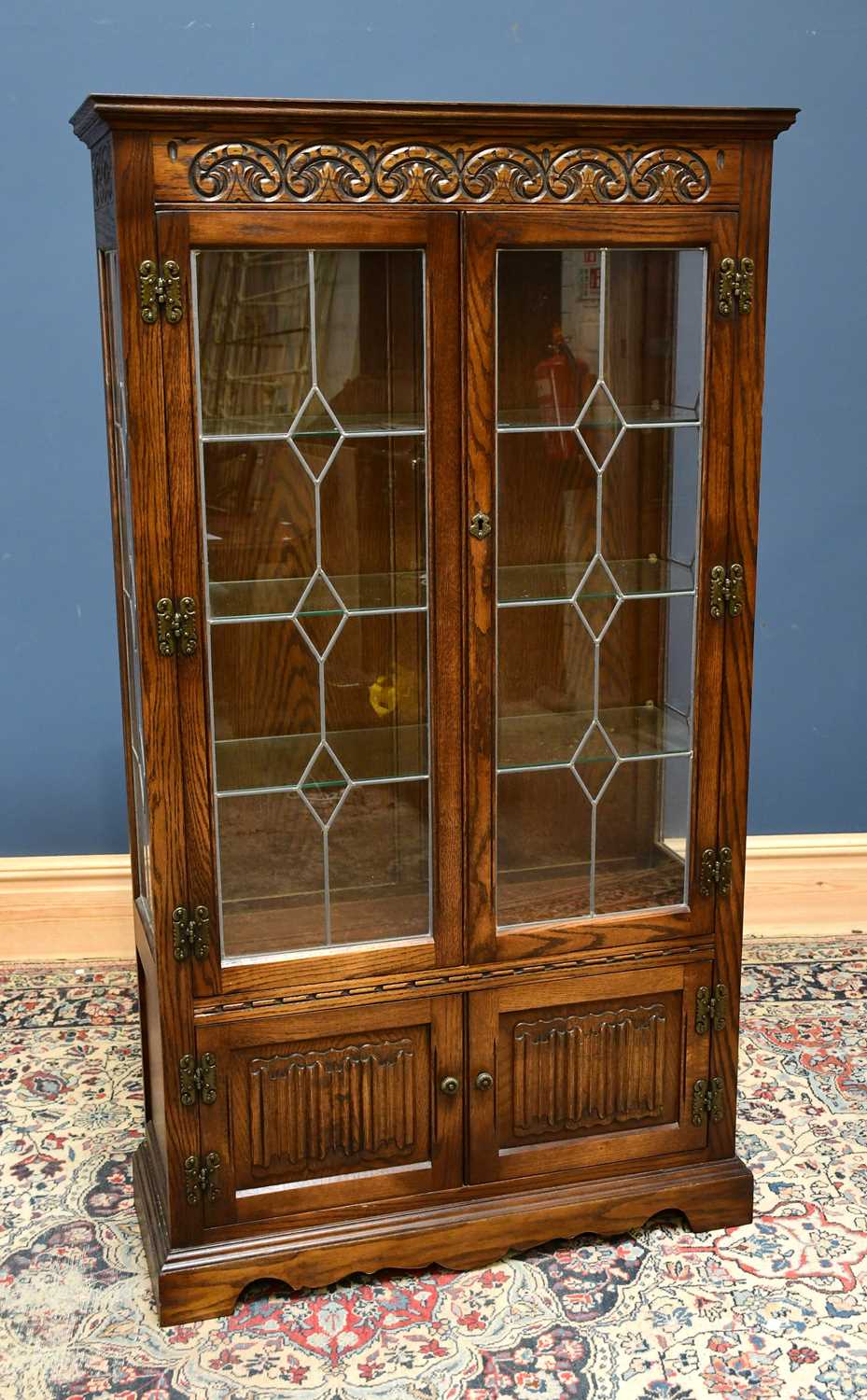 Lot 1715 - A reproduction oak display cabinet with
