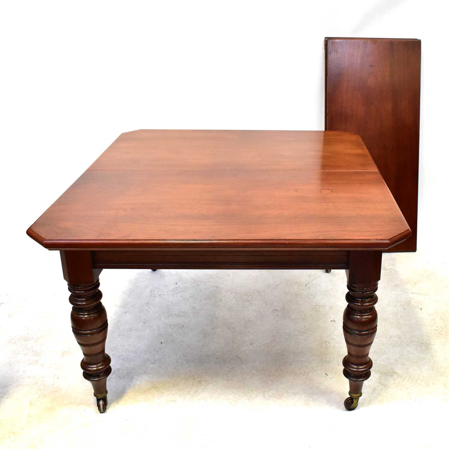 Lot 56 - A Victorian mahogany wind-out table with vase