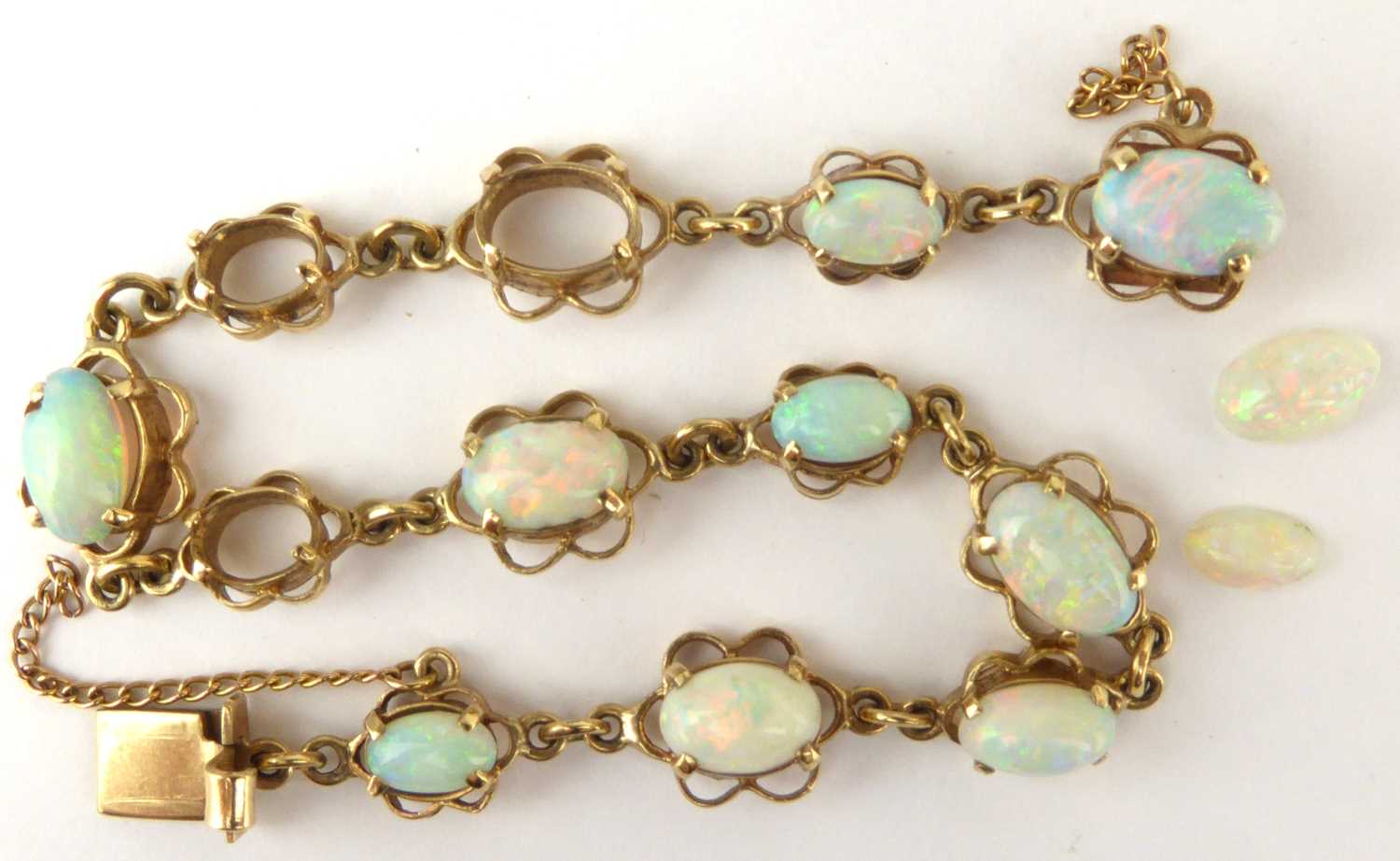 Lot 1021 - A 9ct gold and opal bracelet, the dainty