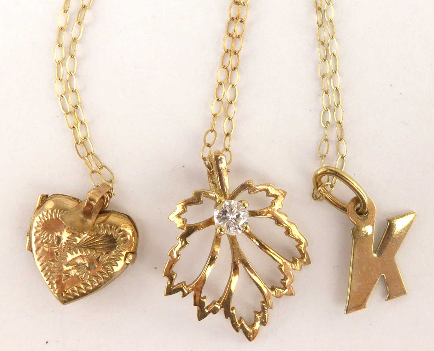 Lot 1125 - Three 9ct gold dainty necklaces, each with