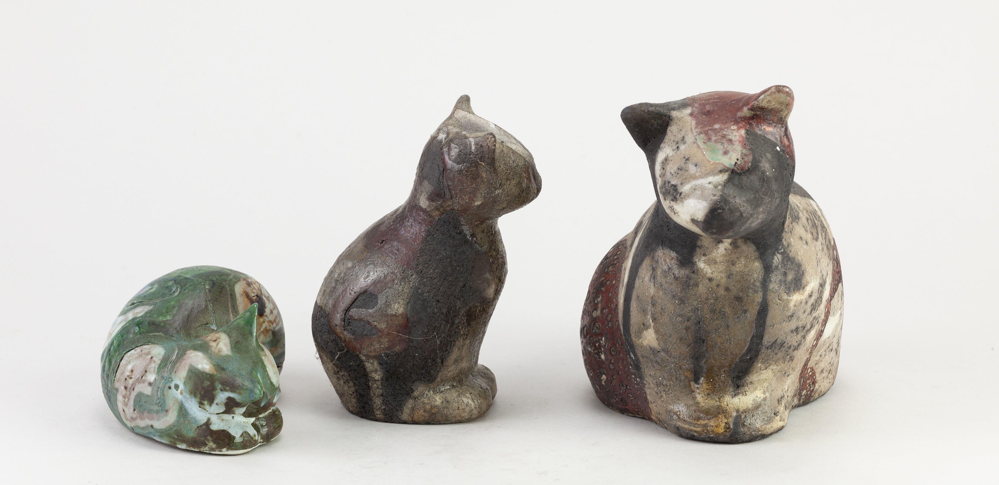 Lot 456 - JOAN DOHERTY (born 1949); a trio of raku cat