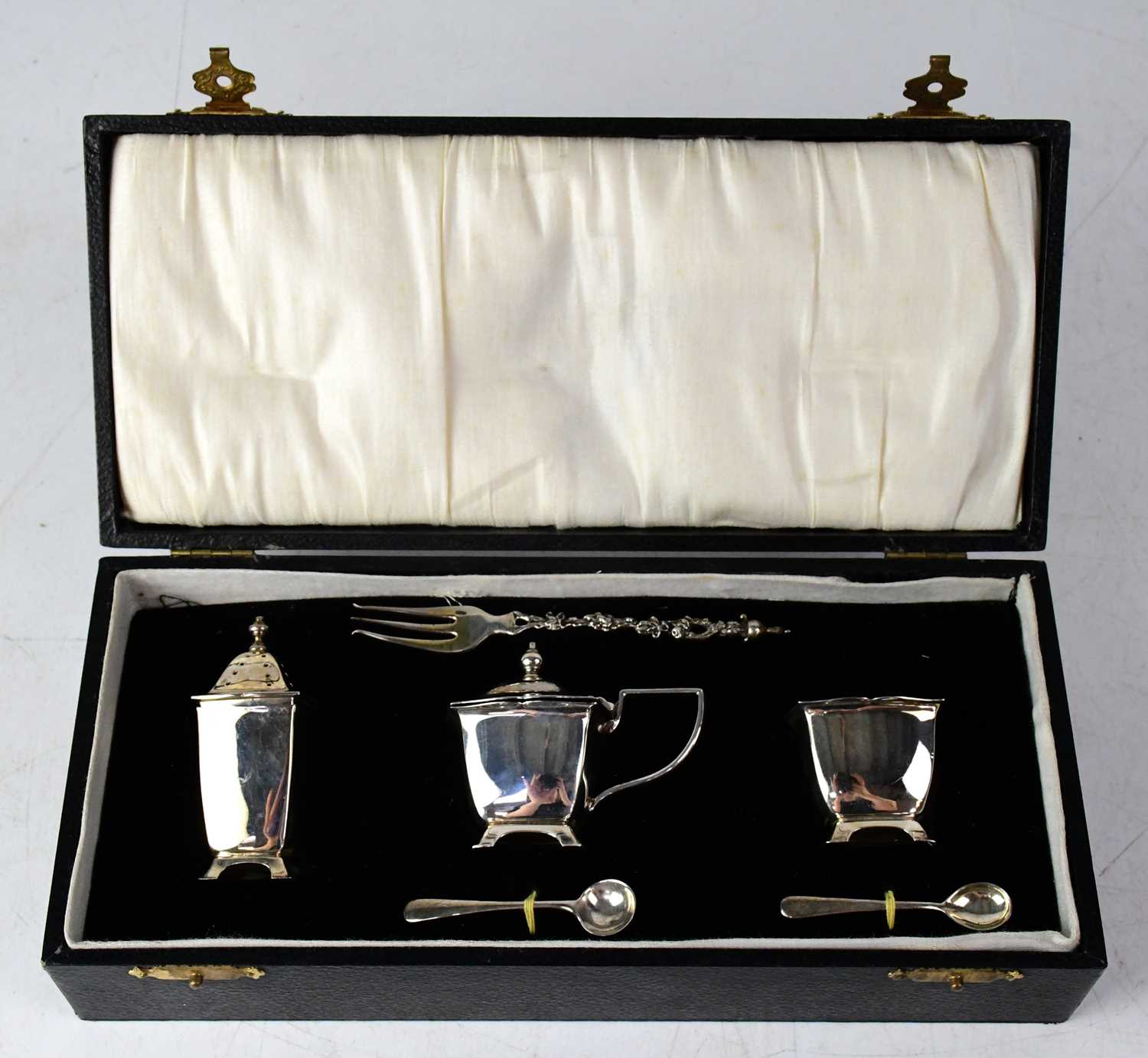 Lot 779 - A cased white metal three-piece cruet set,