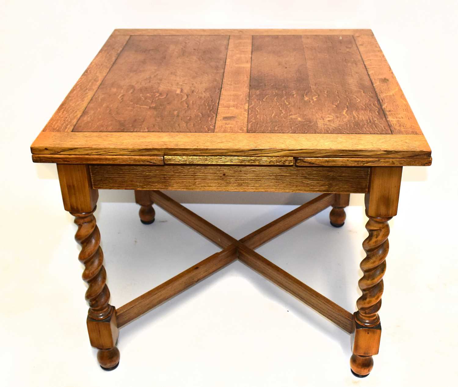 Lot 1491 - A 1930s oak draw-leaf table, with twist