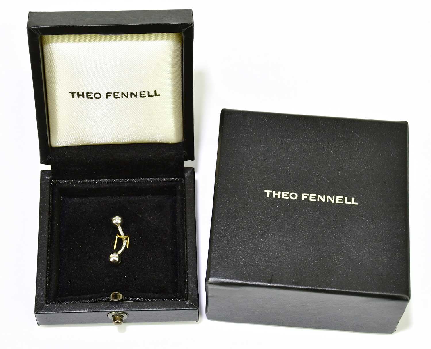Lot 589 - THEO FENNELL; an 18ct white gold belly bar