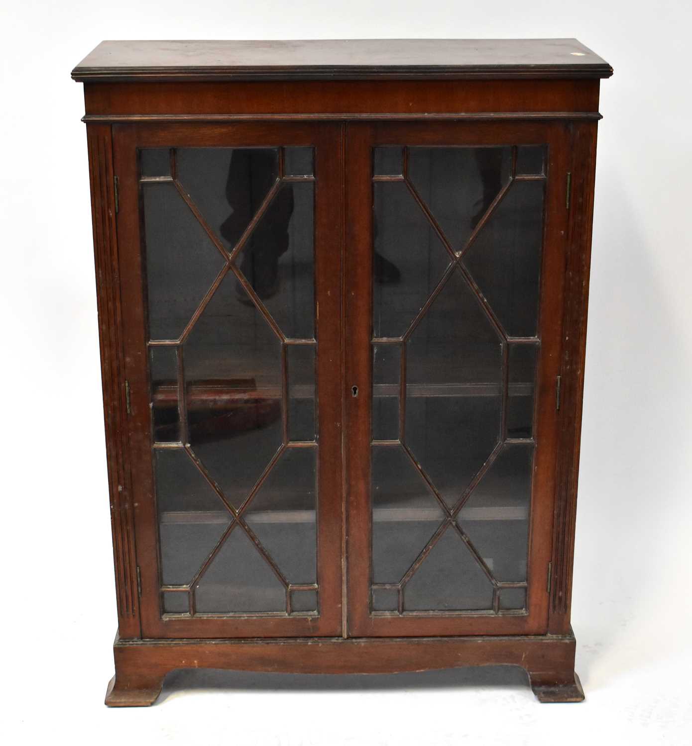 Lot 21 - A reproduction mahogany display cabinet of