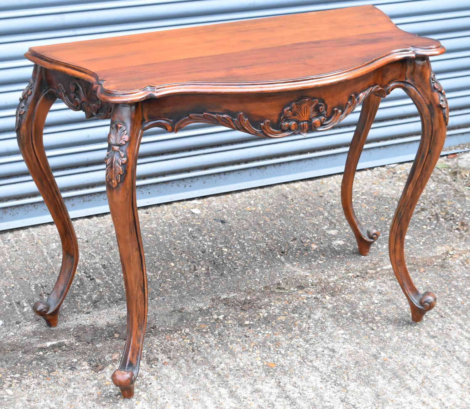 Lot 40 - A reproduction console table of serpentine
