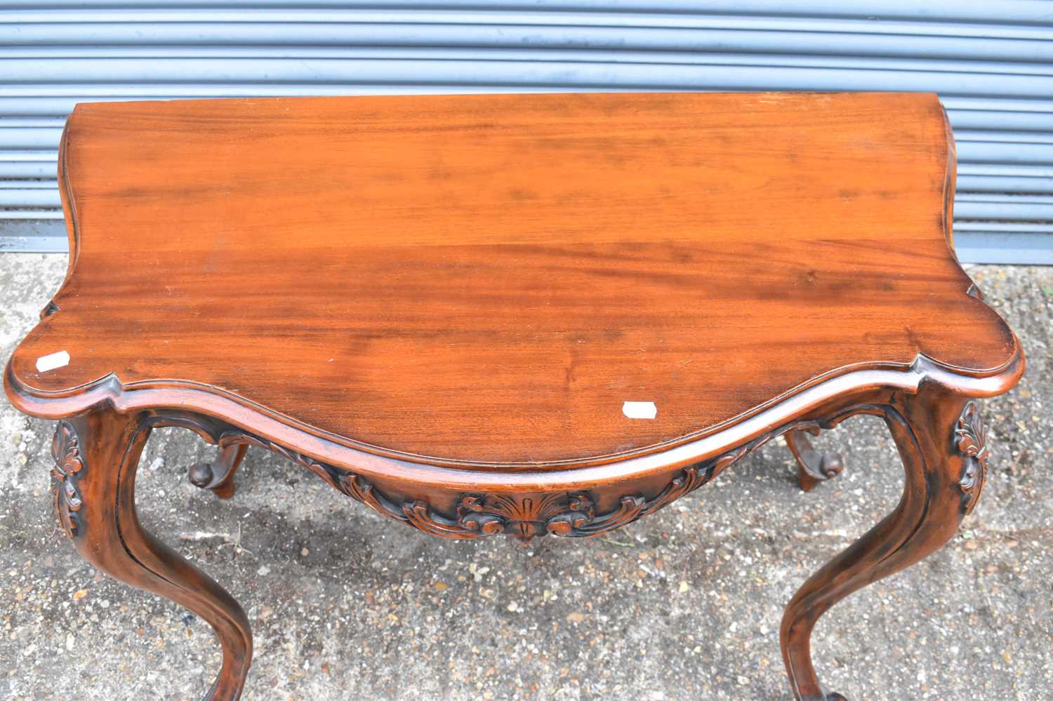 Lot 40 - A reproduction console table of serpentine